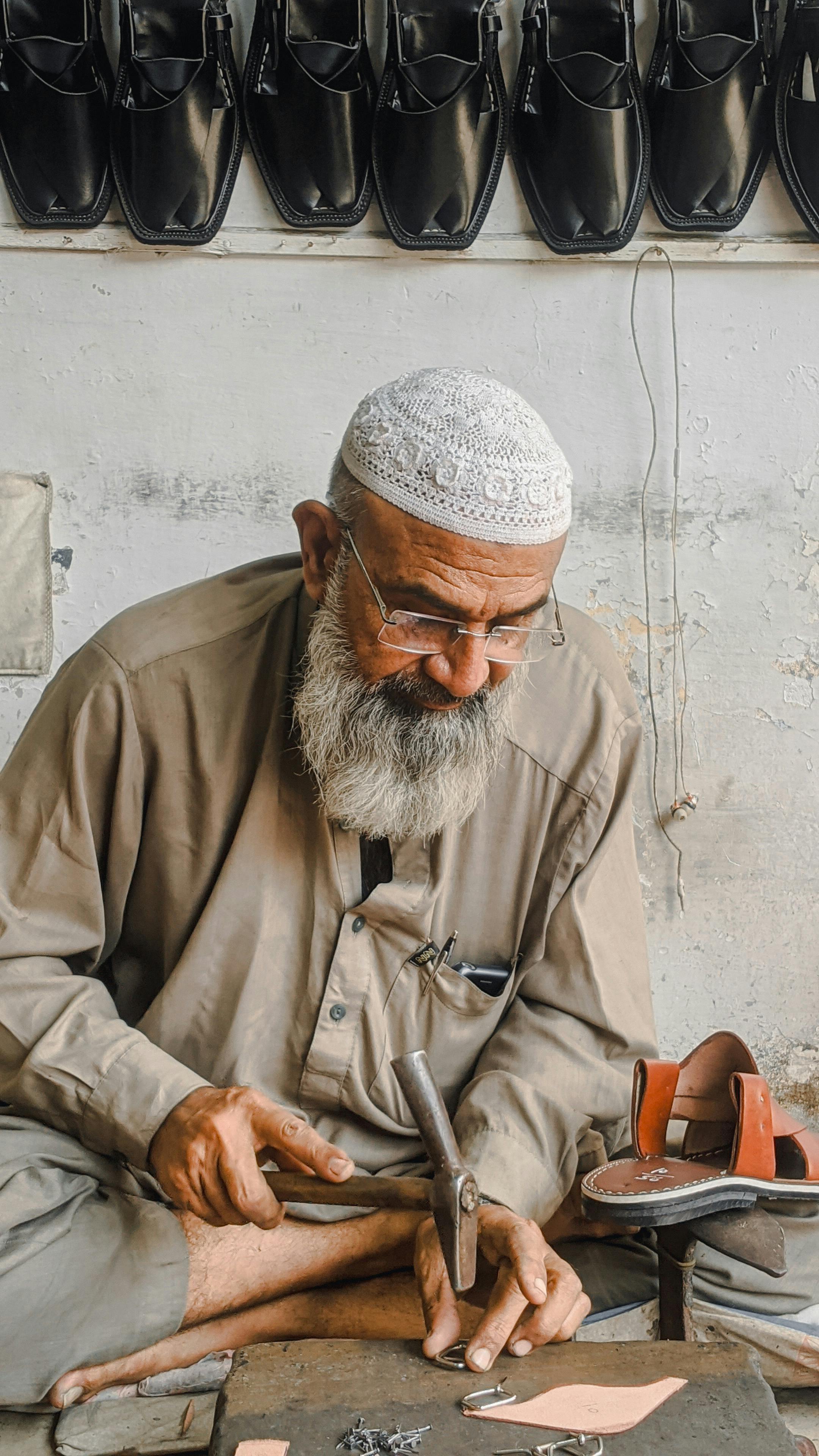 Elderly Shoemaker Sitting and Working · Free Stock Photo