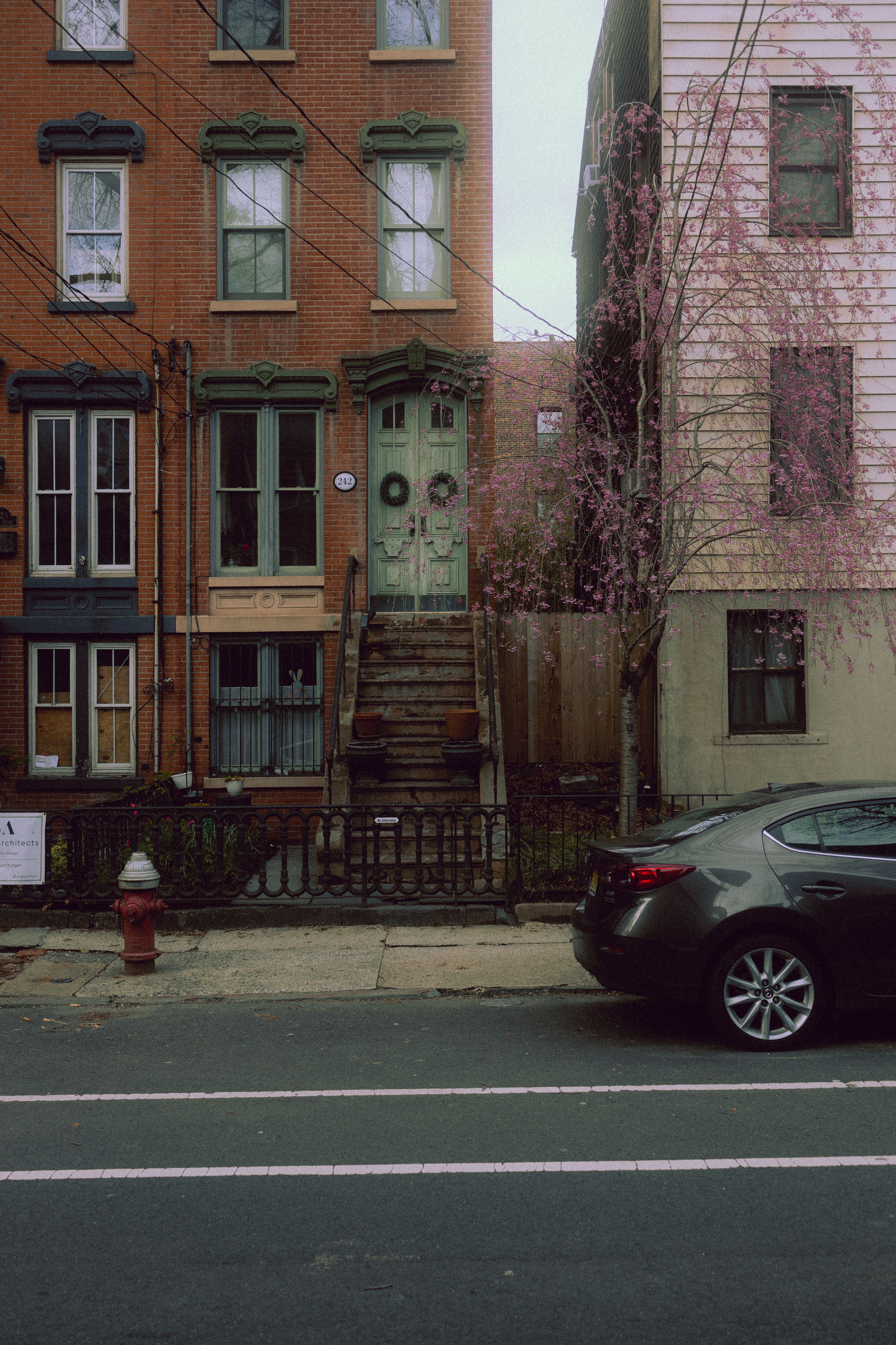 A car parked in front of a house on a street · Free Stock Photo