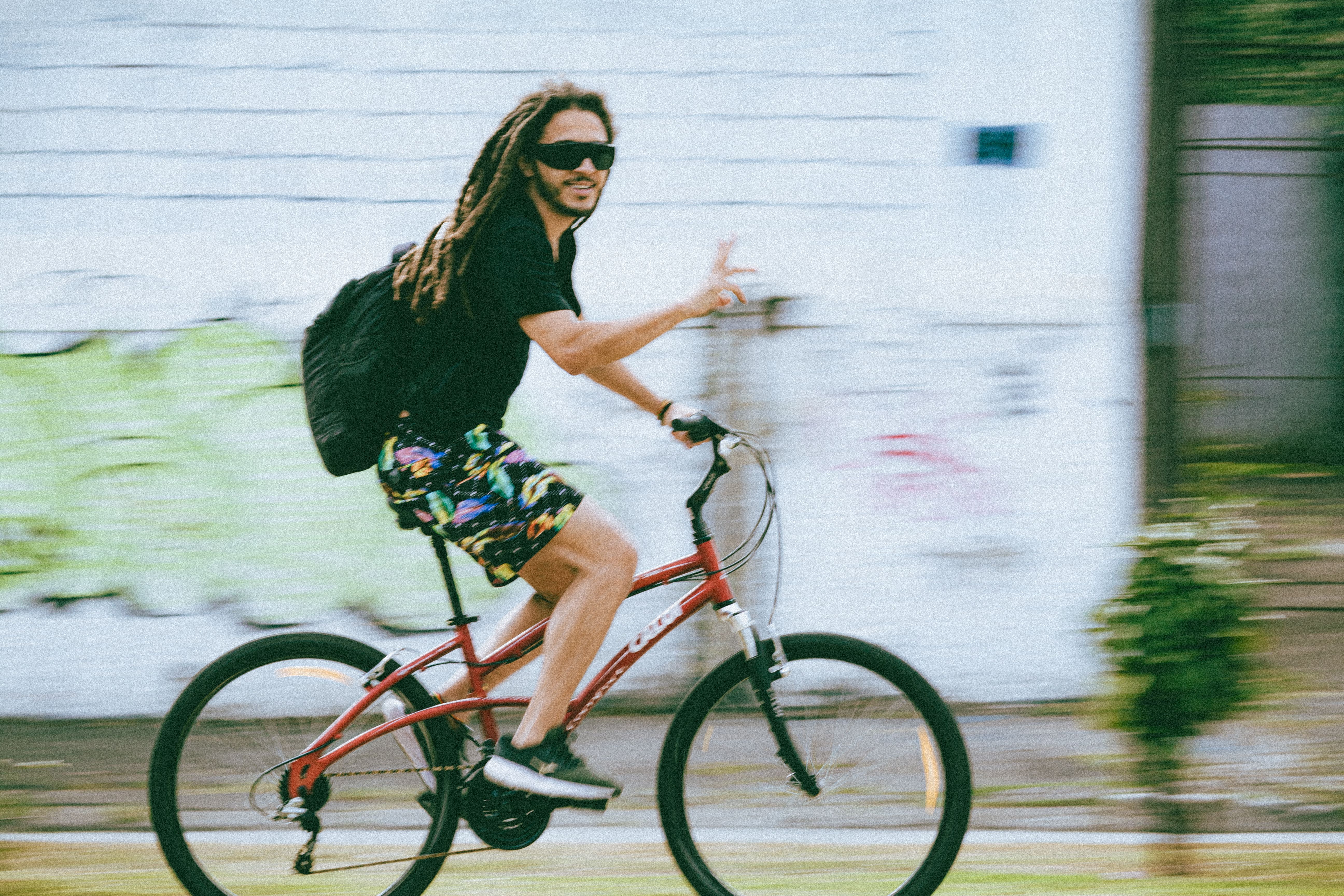 Smiling Man Riding Bicycle on Street · Free Stock Photo