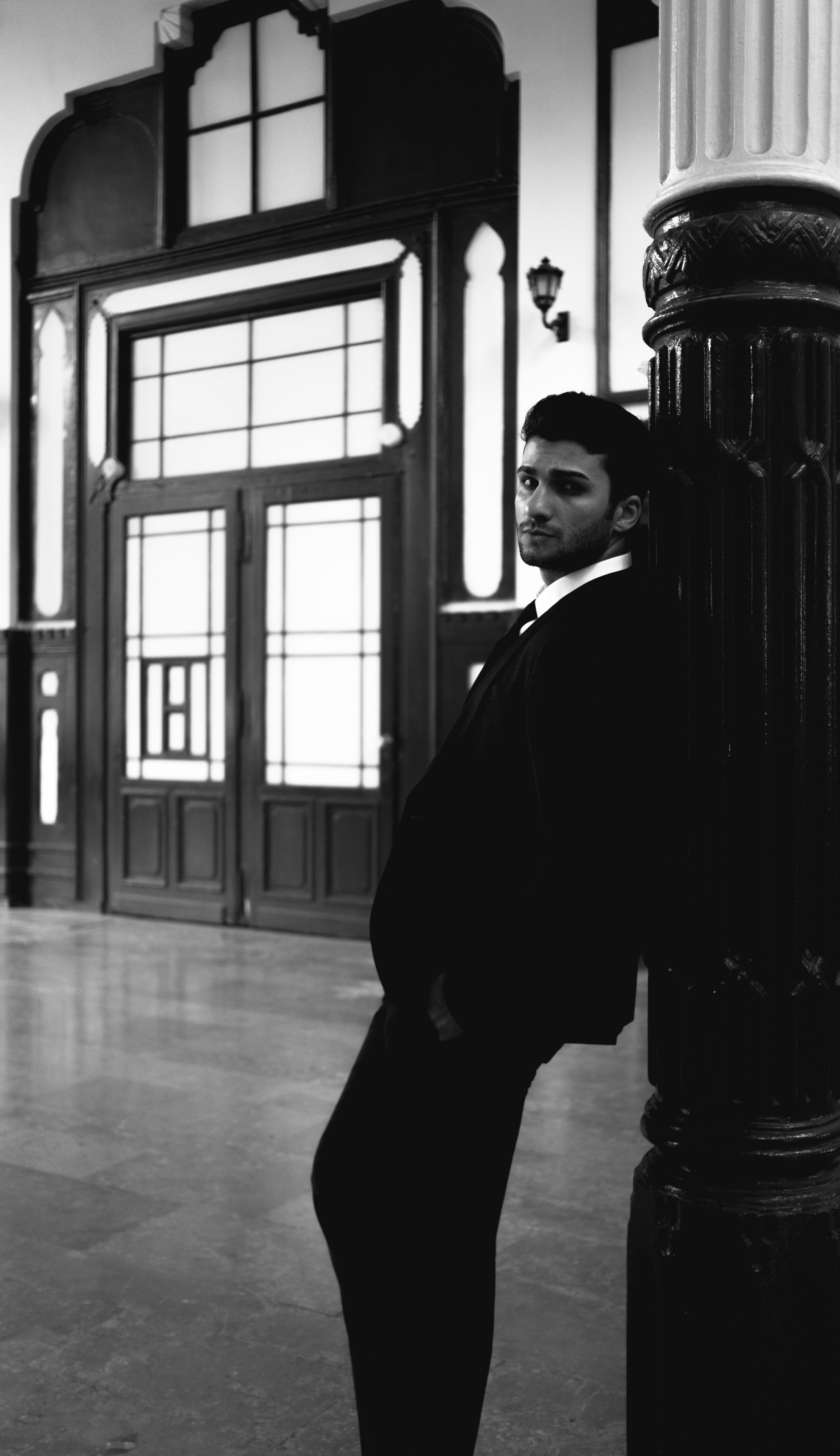 Elegant Man Leaning on a Column · Free Stock Photo