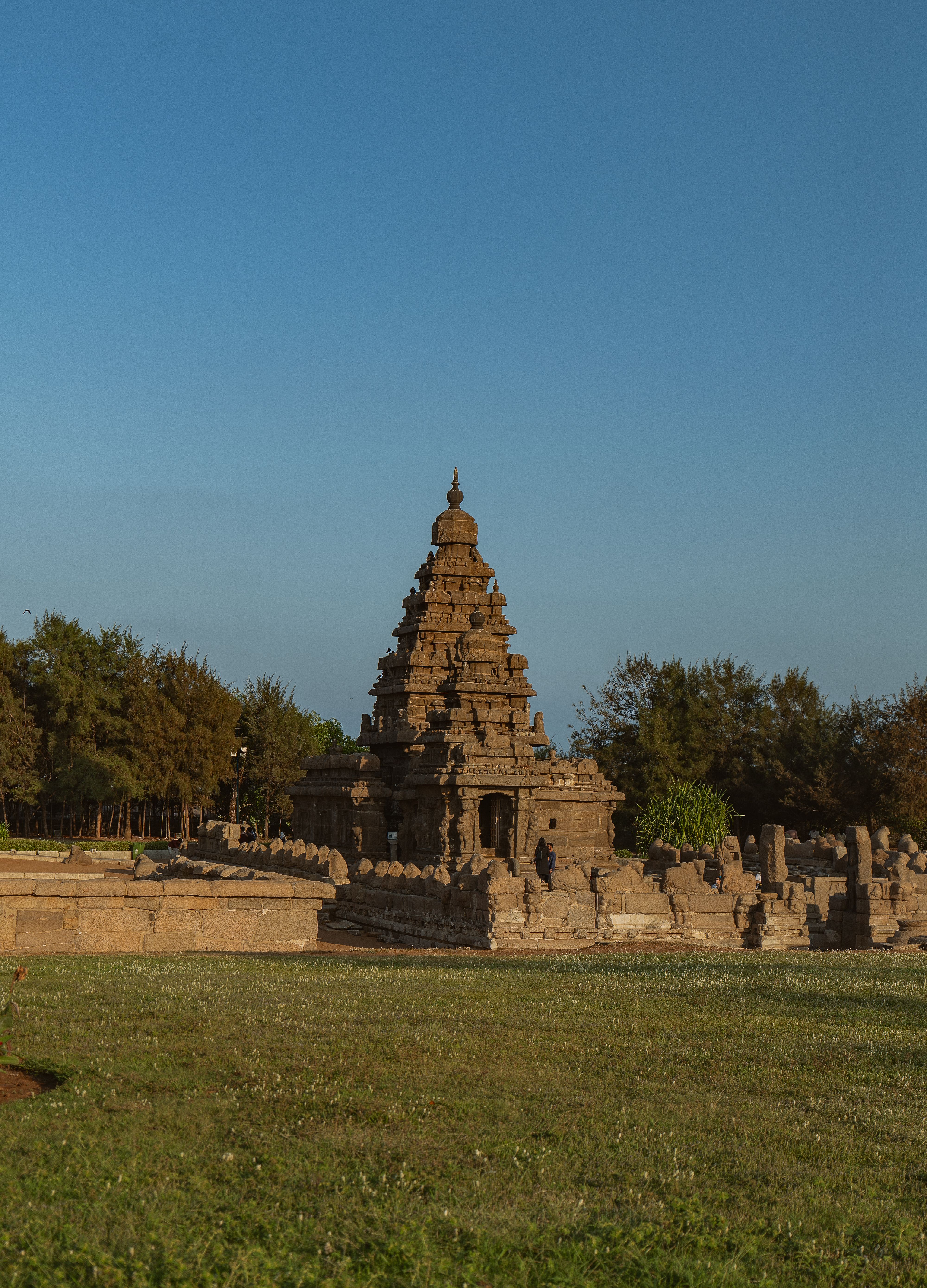 The temple is surrounded by green grass and trees · Free Stock Photo