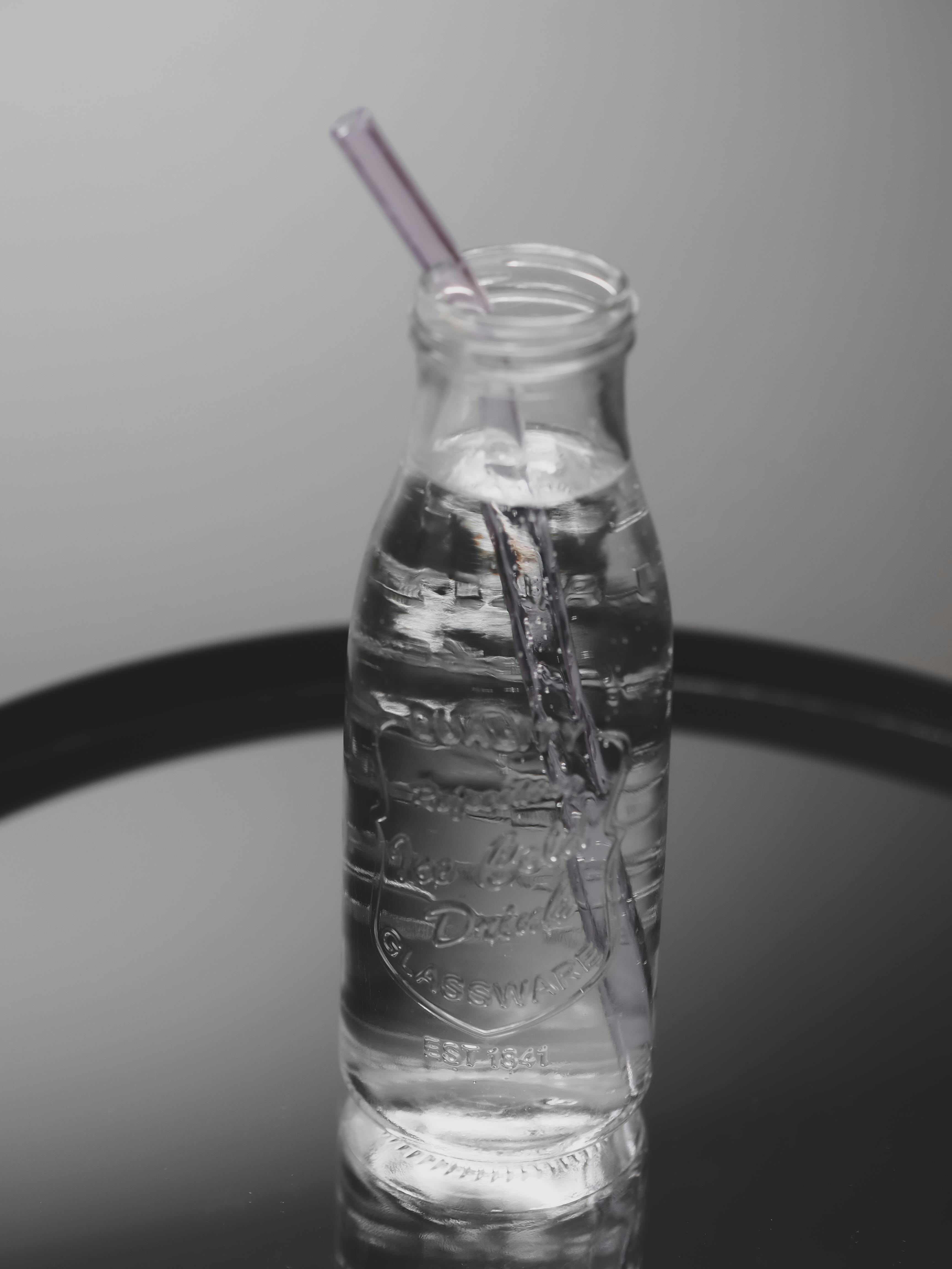 Glass Bottle of Water with a Straw · Free Stock Photo