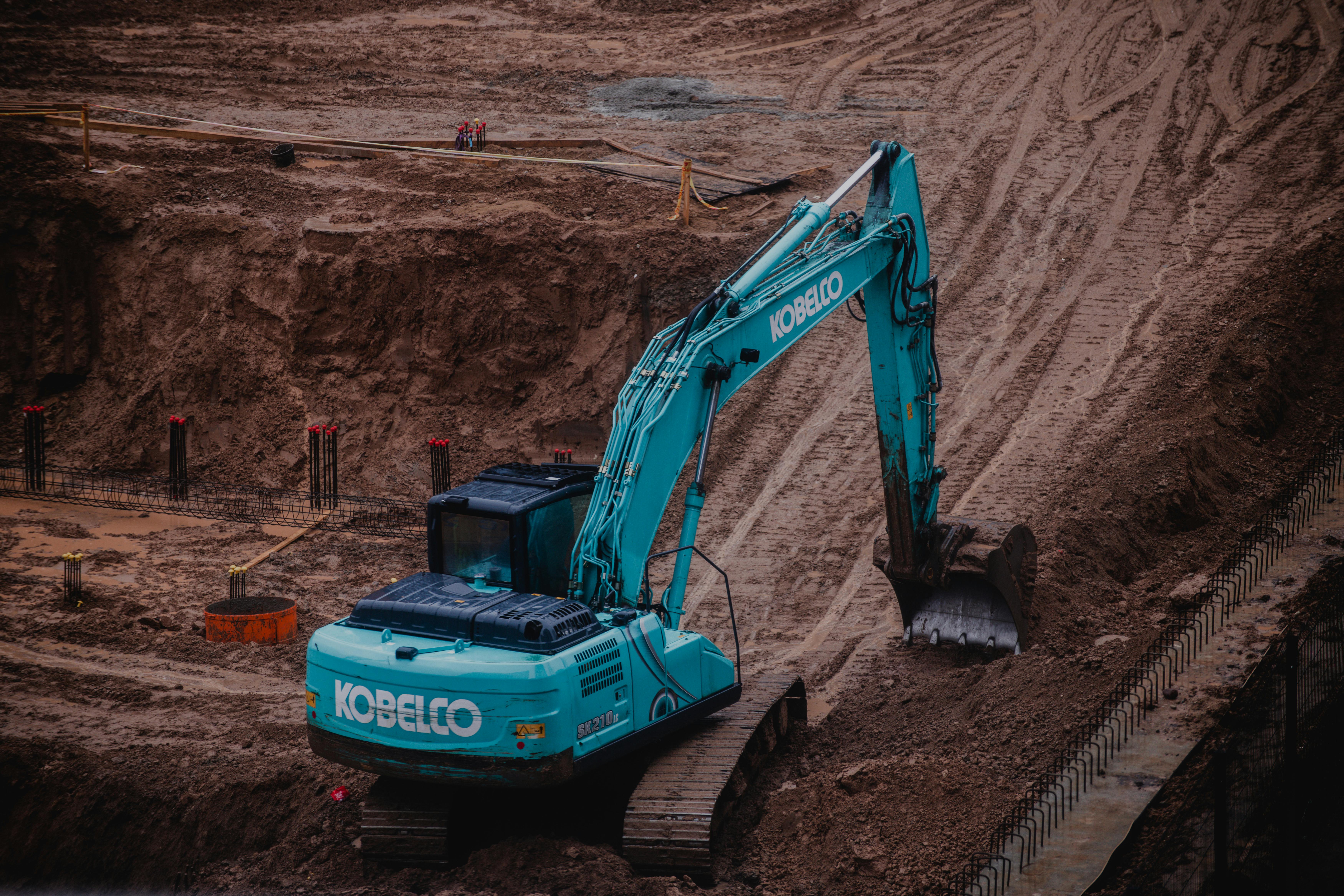 Excavator Scooping Sand on a Construction Site · Free Stock Photo