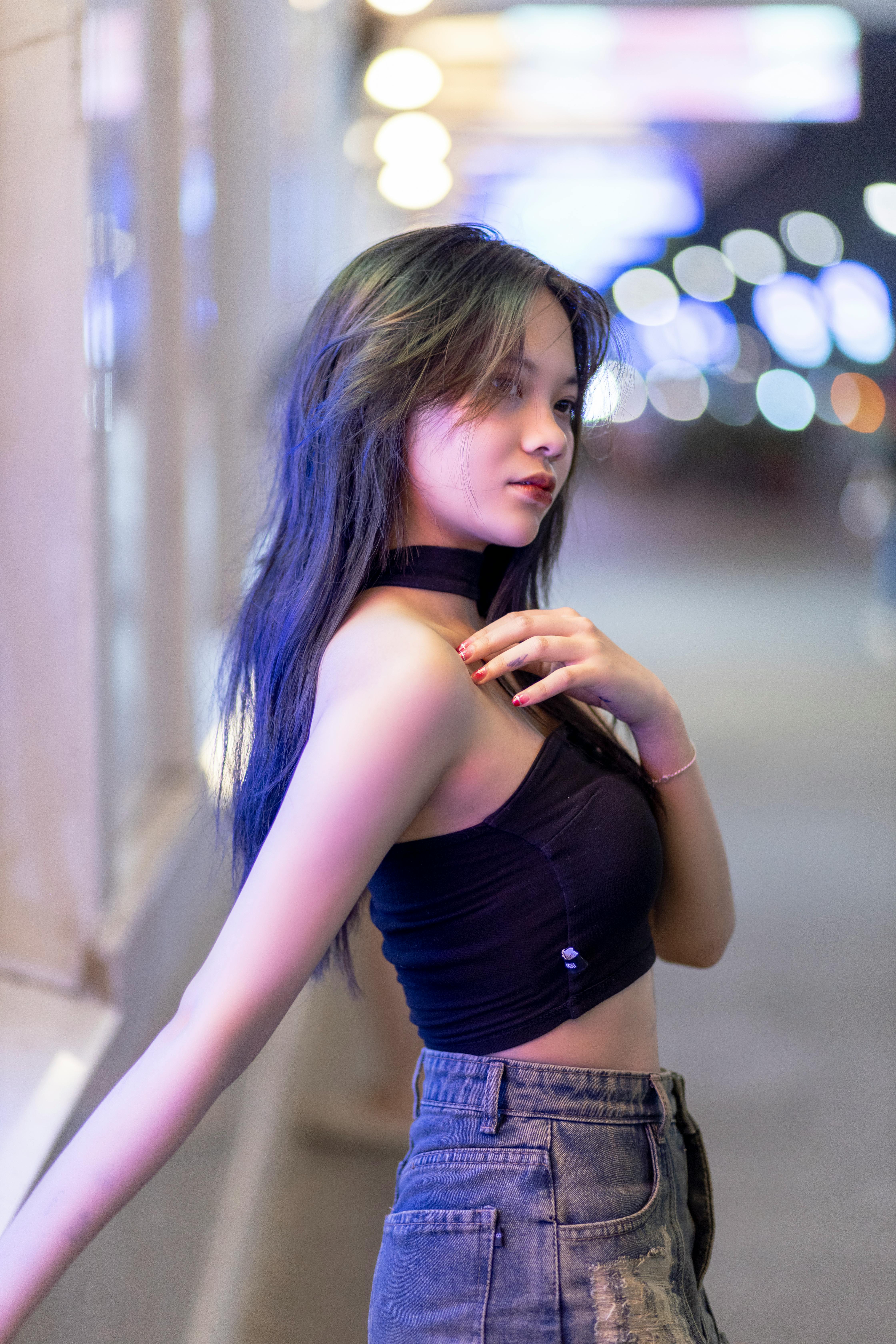 Woman Sitting On The Ledge Of A Rooftop · Free Stock Photo