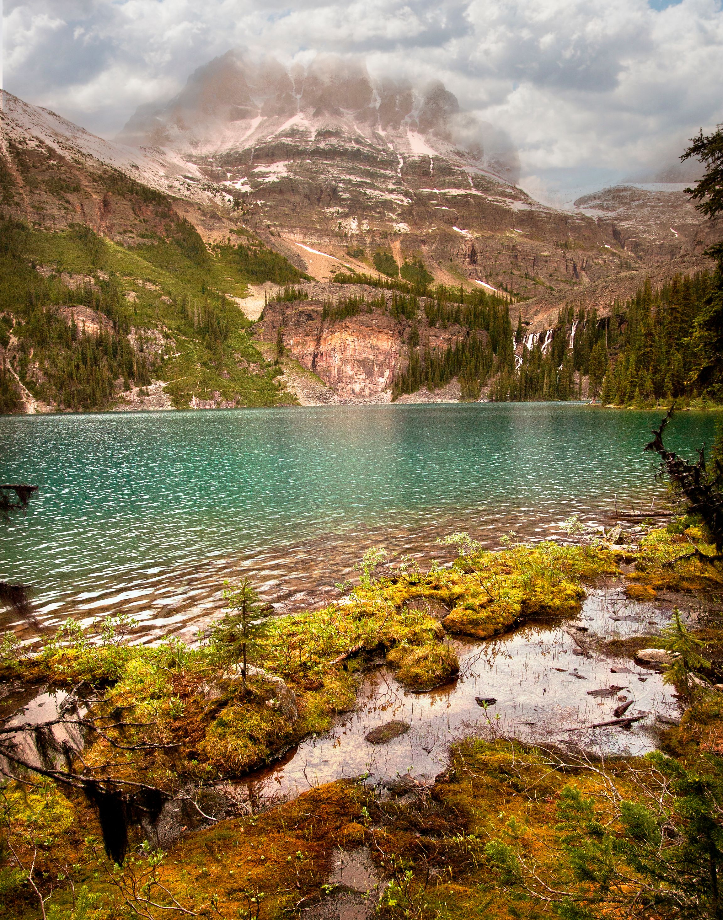 Lake at the Foot of a Steep Mountain with a Peak in the Clouds · Free ...