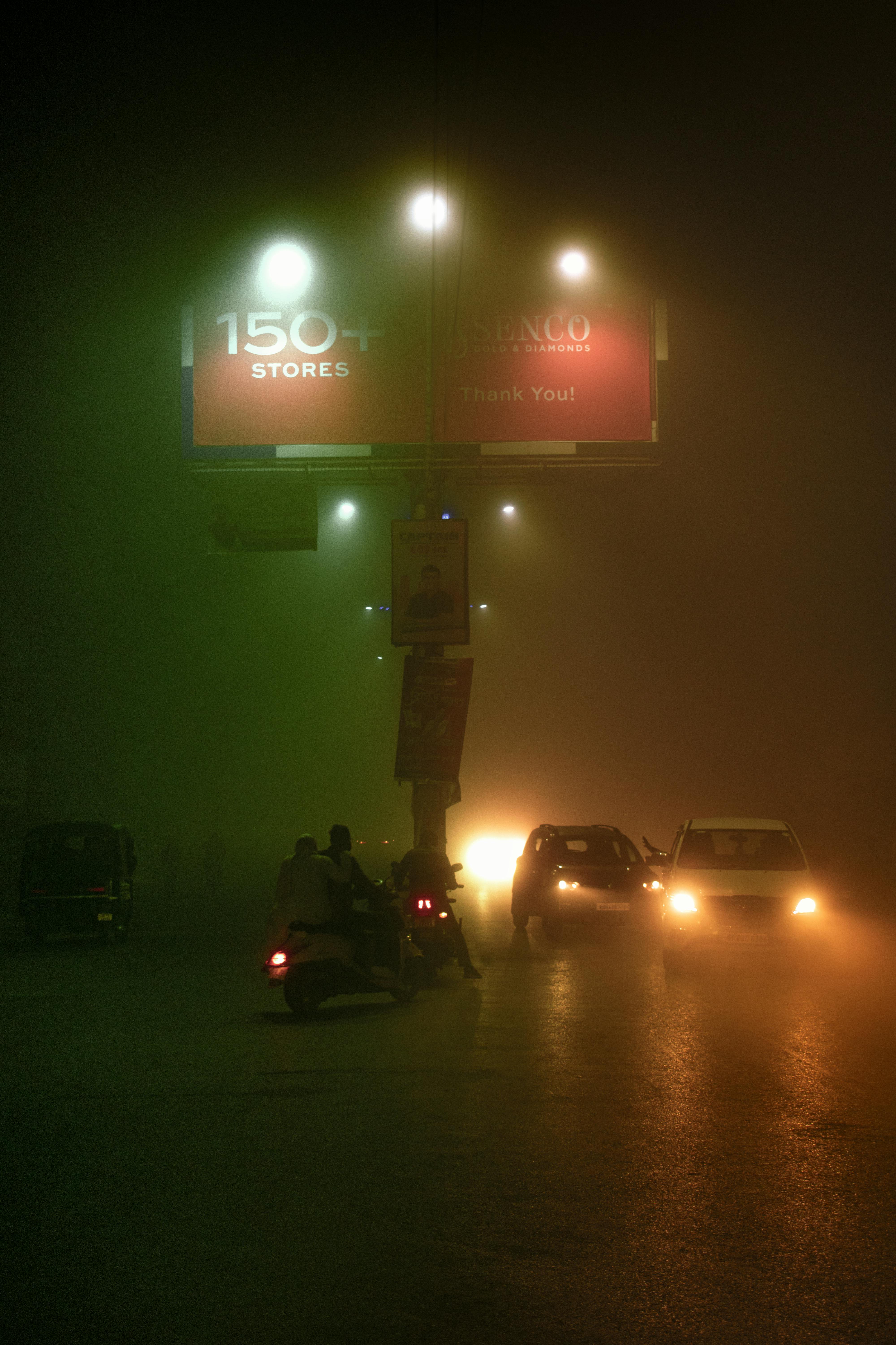 Traffic in the Fog Illuminated by Billboard · Free Stock Photo