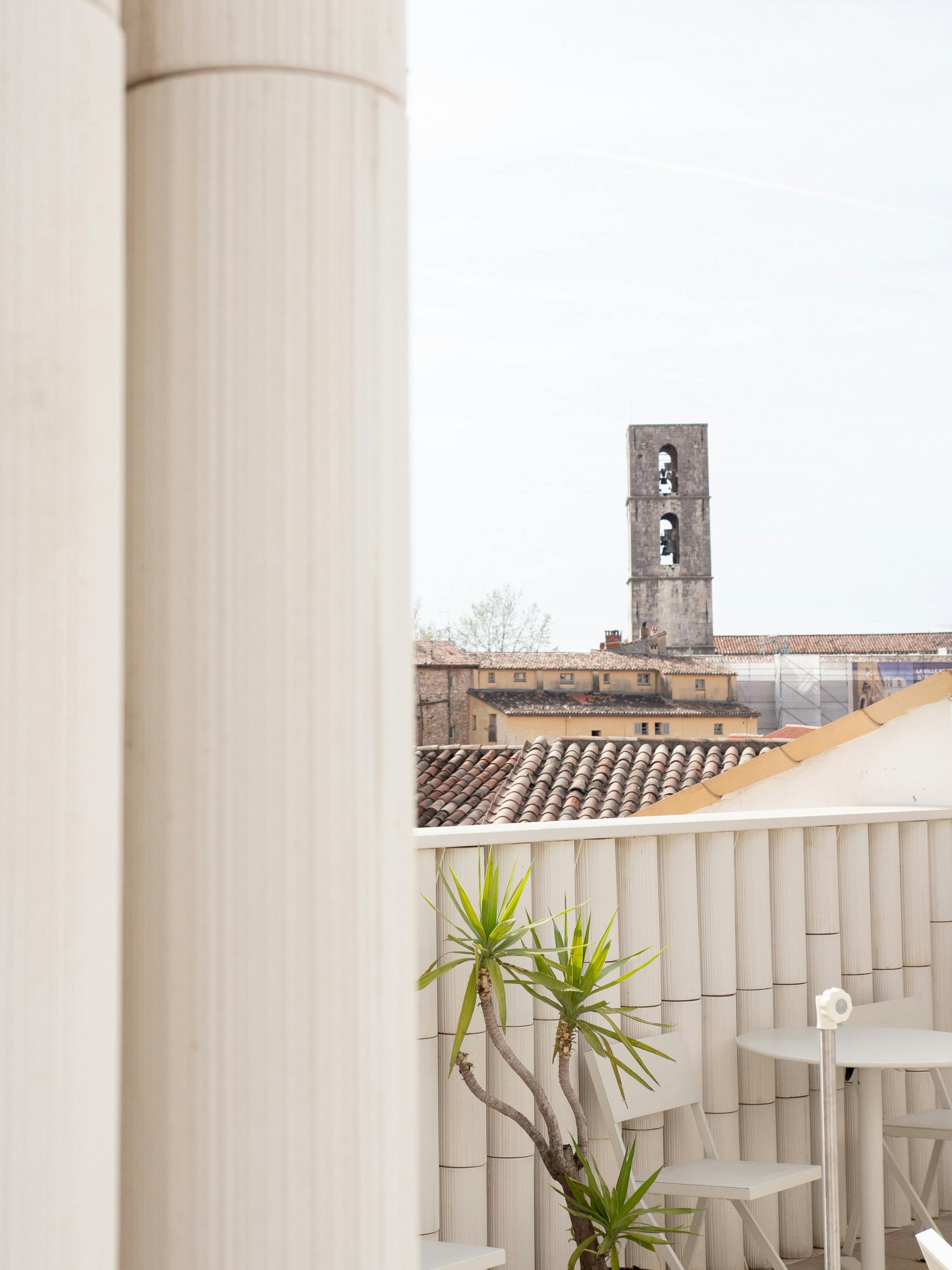 Church Tower over Buildings Rooftops in Town · Free Stock Photo