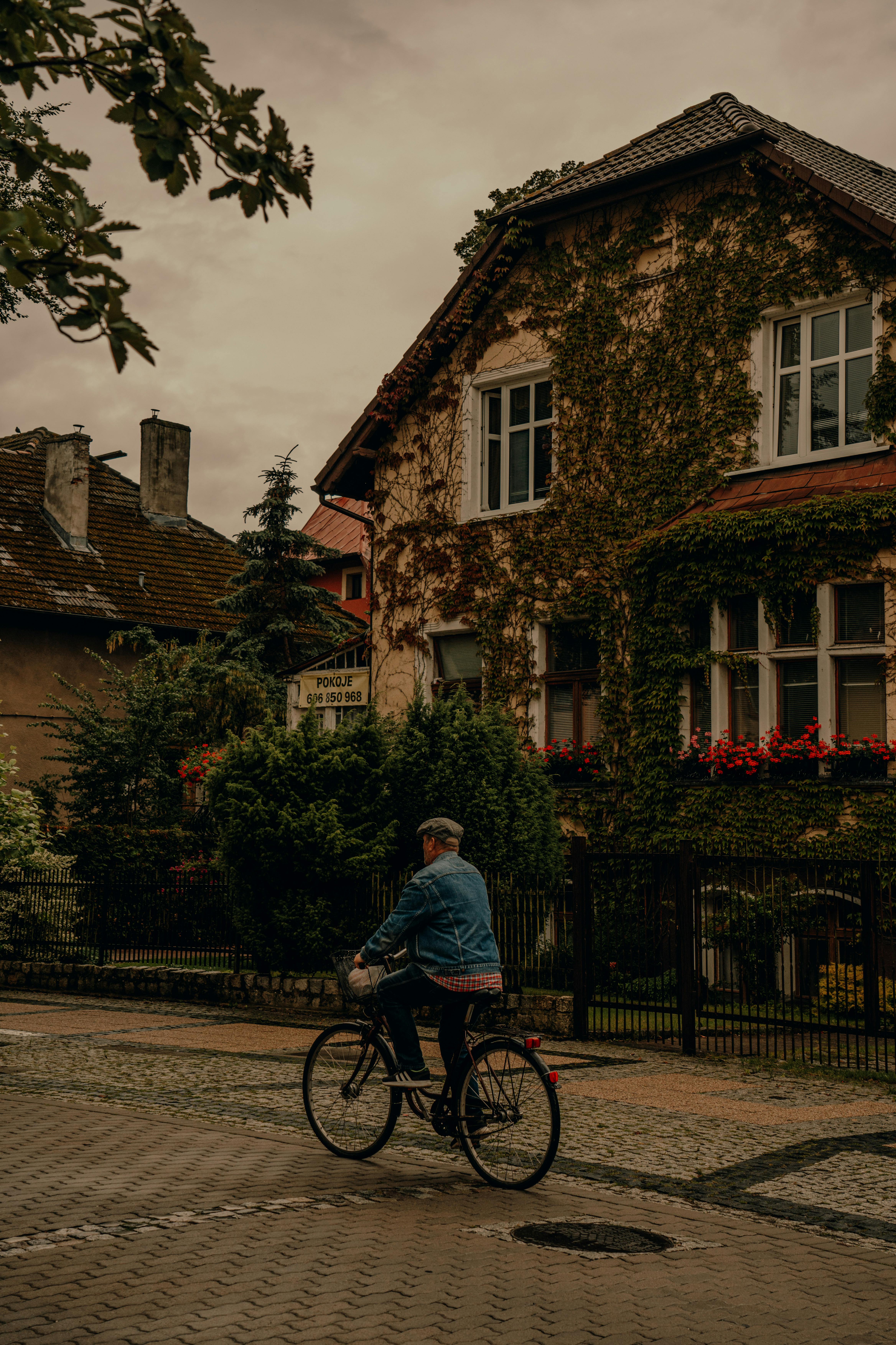 Man Riding a Bicycle through a Scenic Town · Free Stock Photo