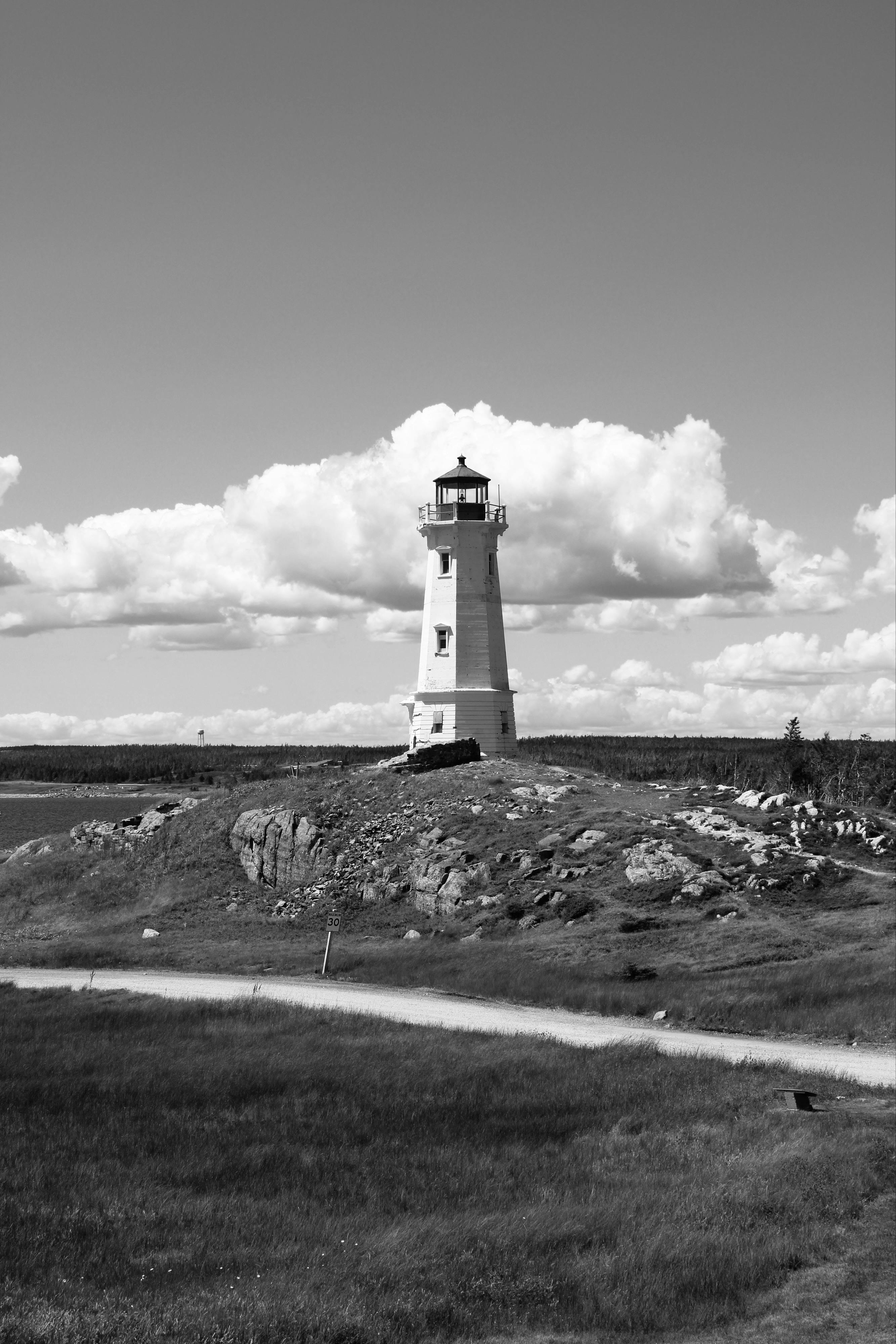 Lighthouse on Hill on Coast · Free Stock Photo