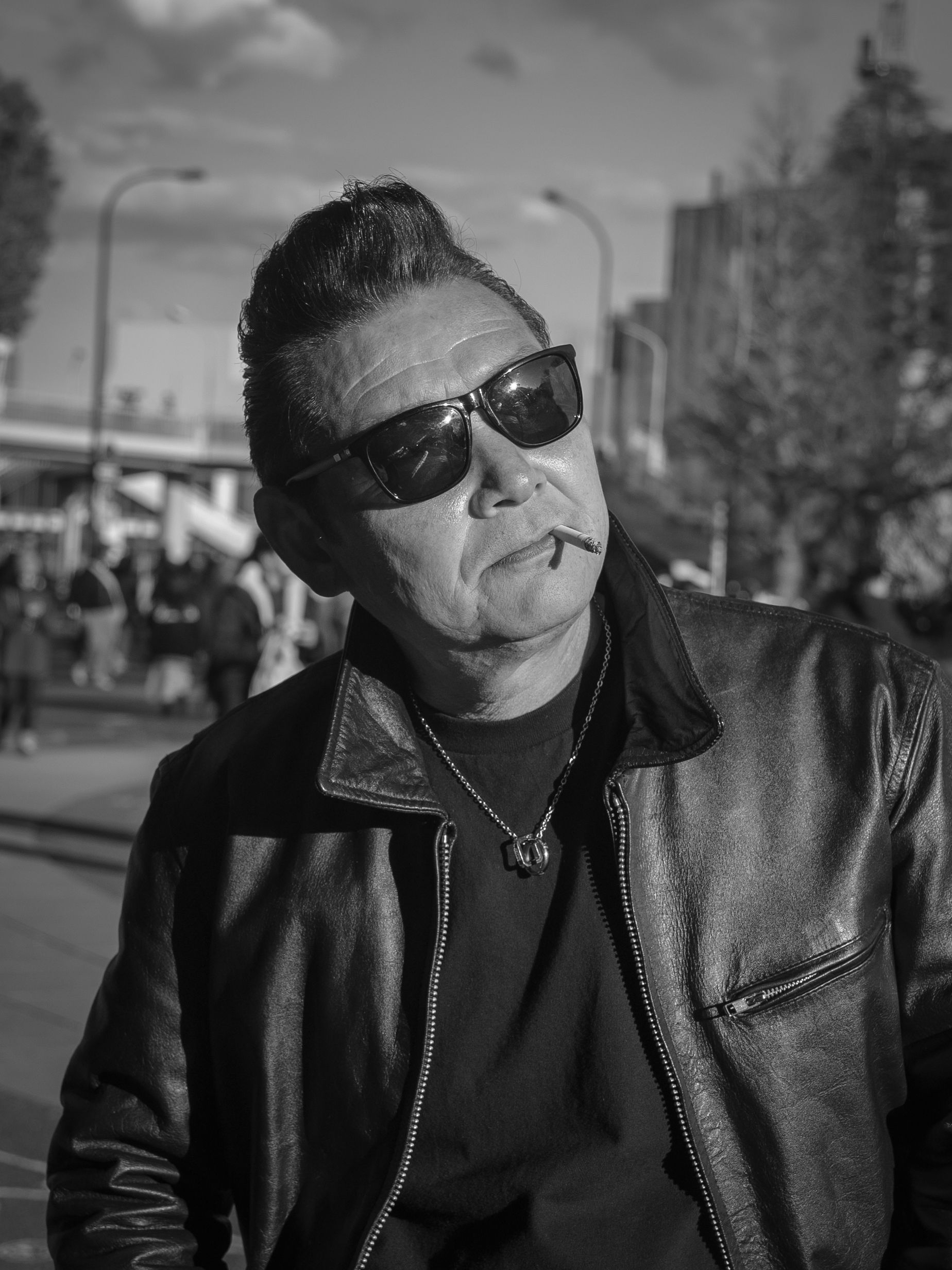 Man in Sunglasses and Leather Jacket Smoking Cigarette · Free Stock Photo