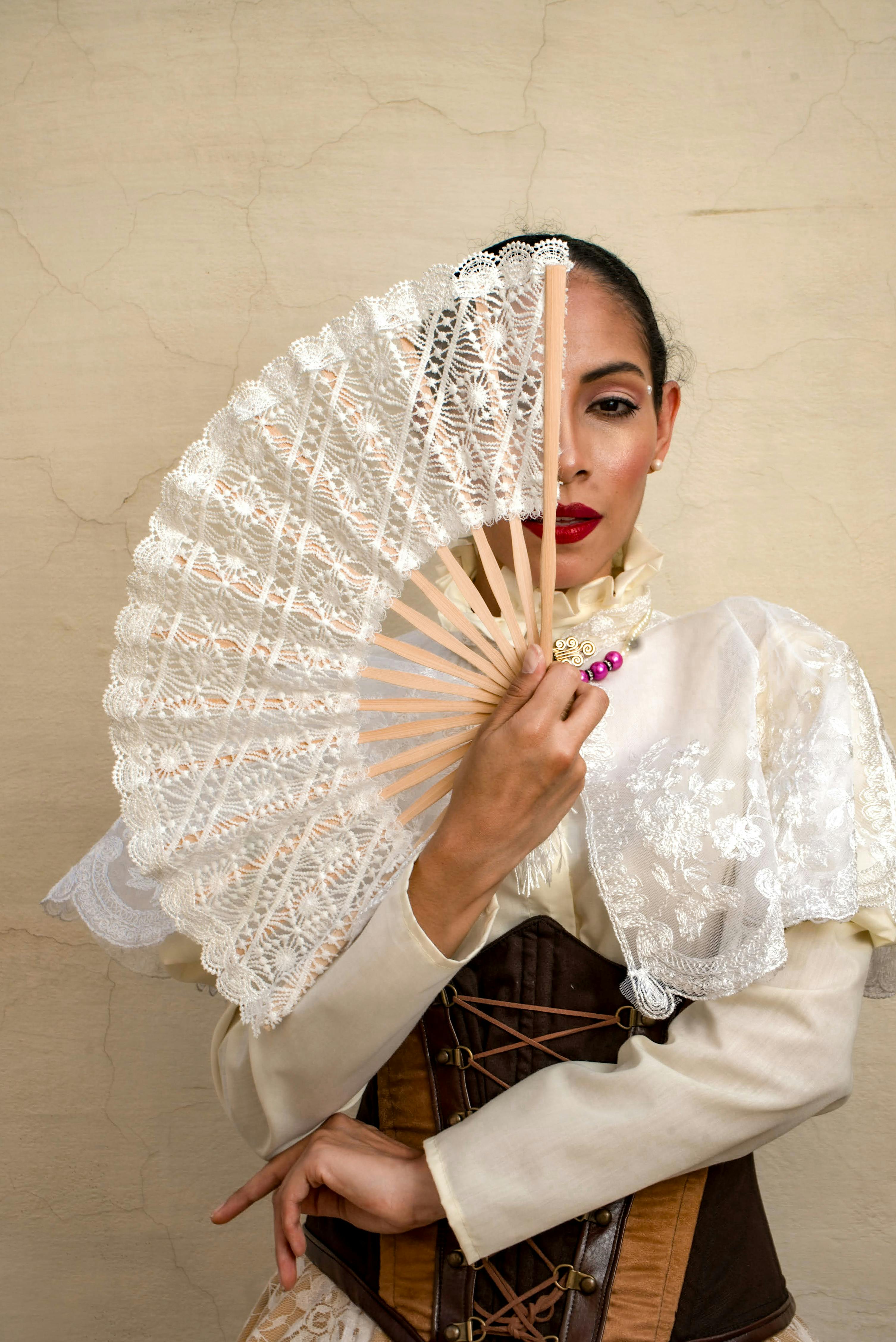 Woman Posing with a Hand Fan · Free Stock Photo