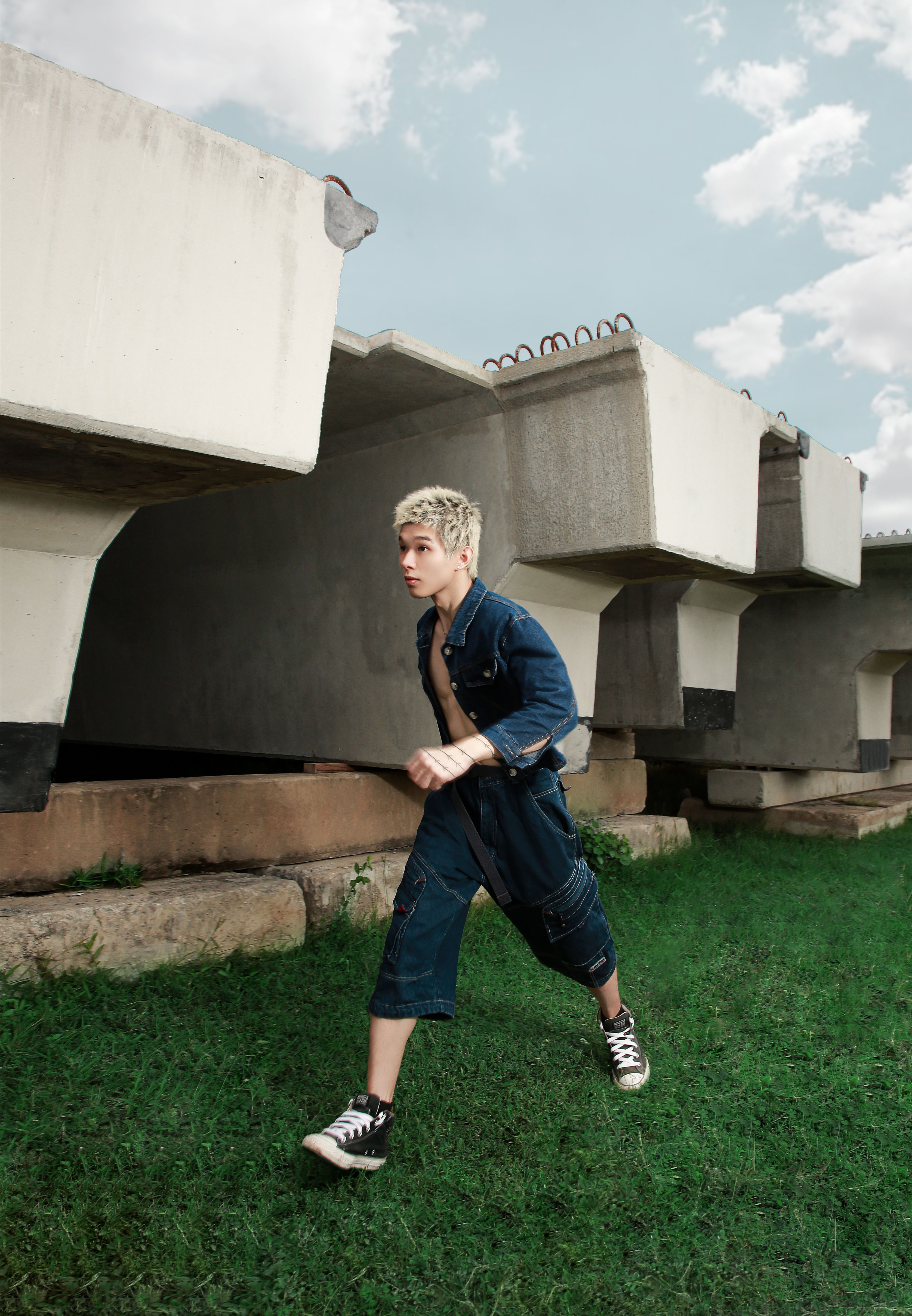 Male Model Wearing Shorts and a Denim Jacket Walking on Grass · Free ...