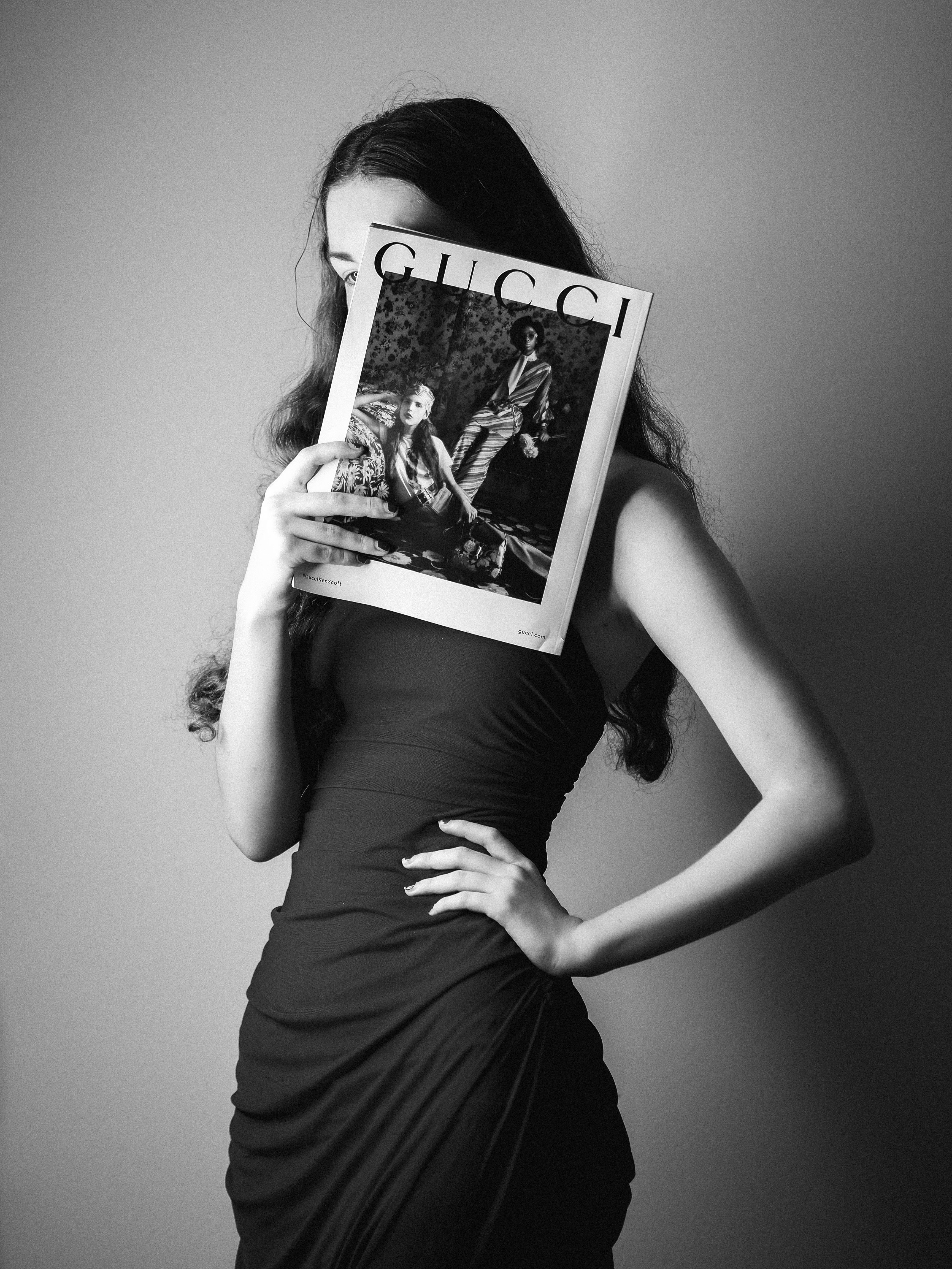 Woman Holding Fashion Magazine in Black and White · Free Stock Photo