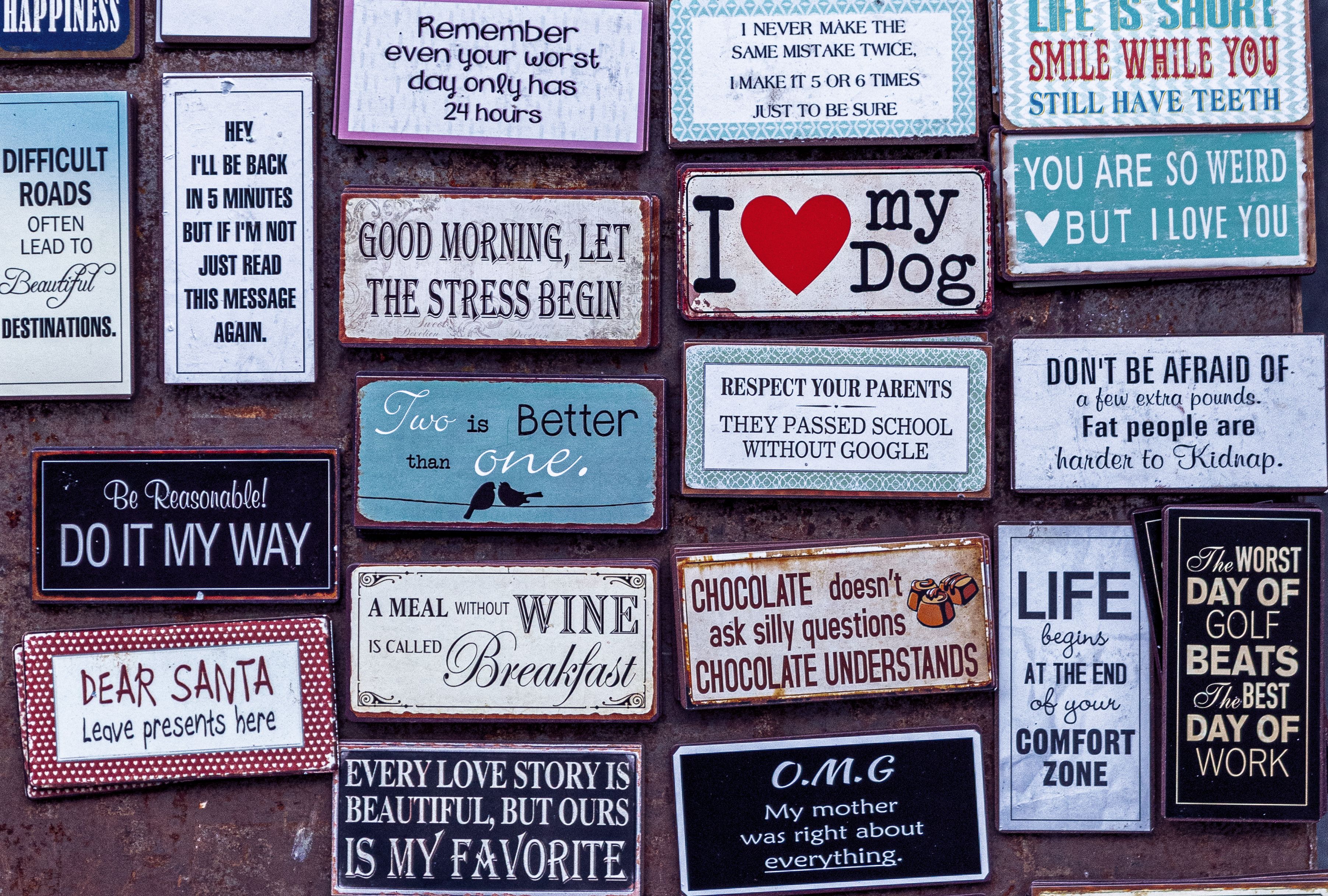 A bunch of different signs on a wall · Free Stock Photo