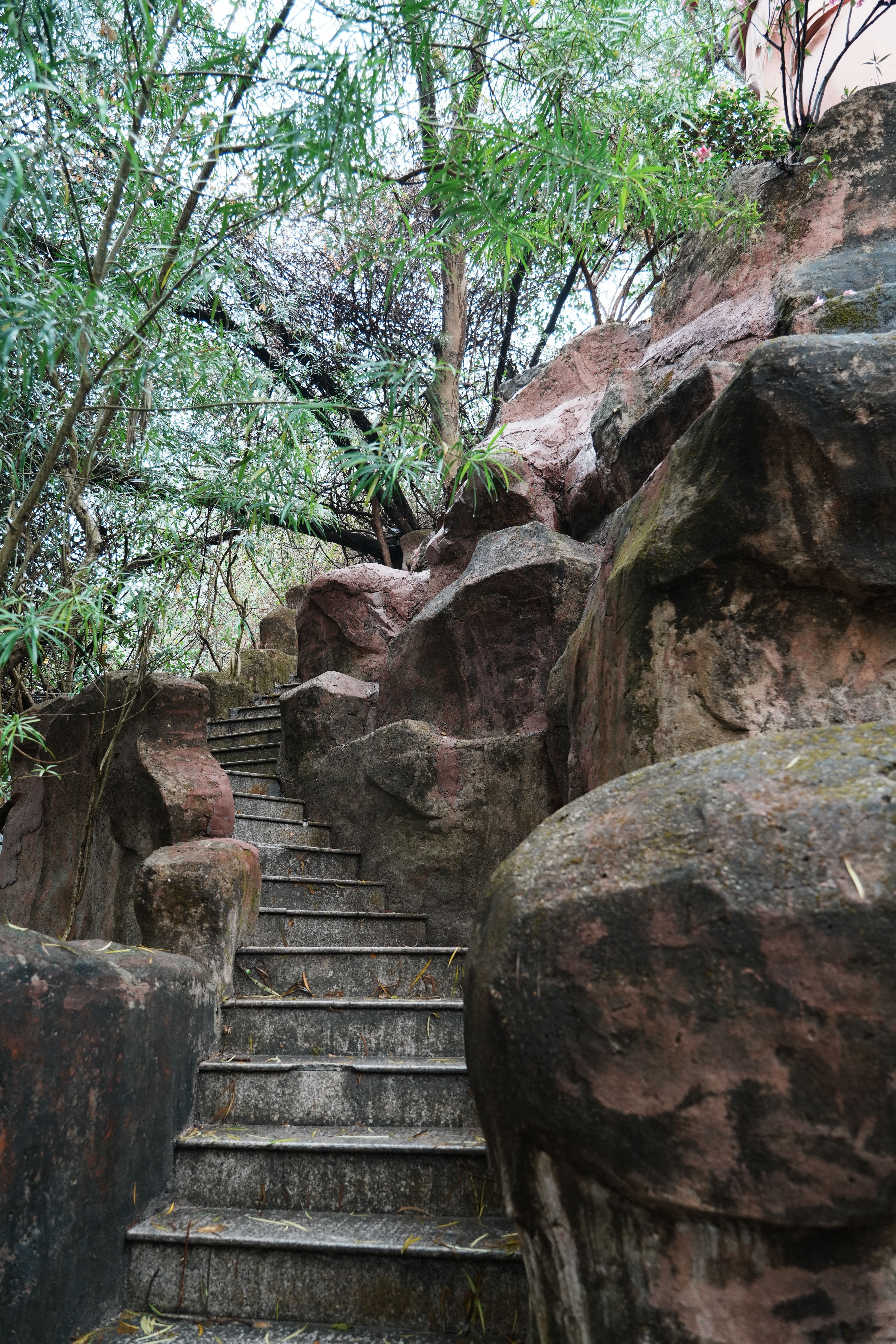 A set of stairs leading up to a rock wall · Free Stock Photo