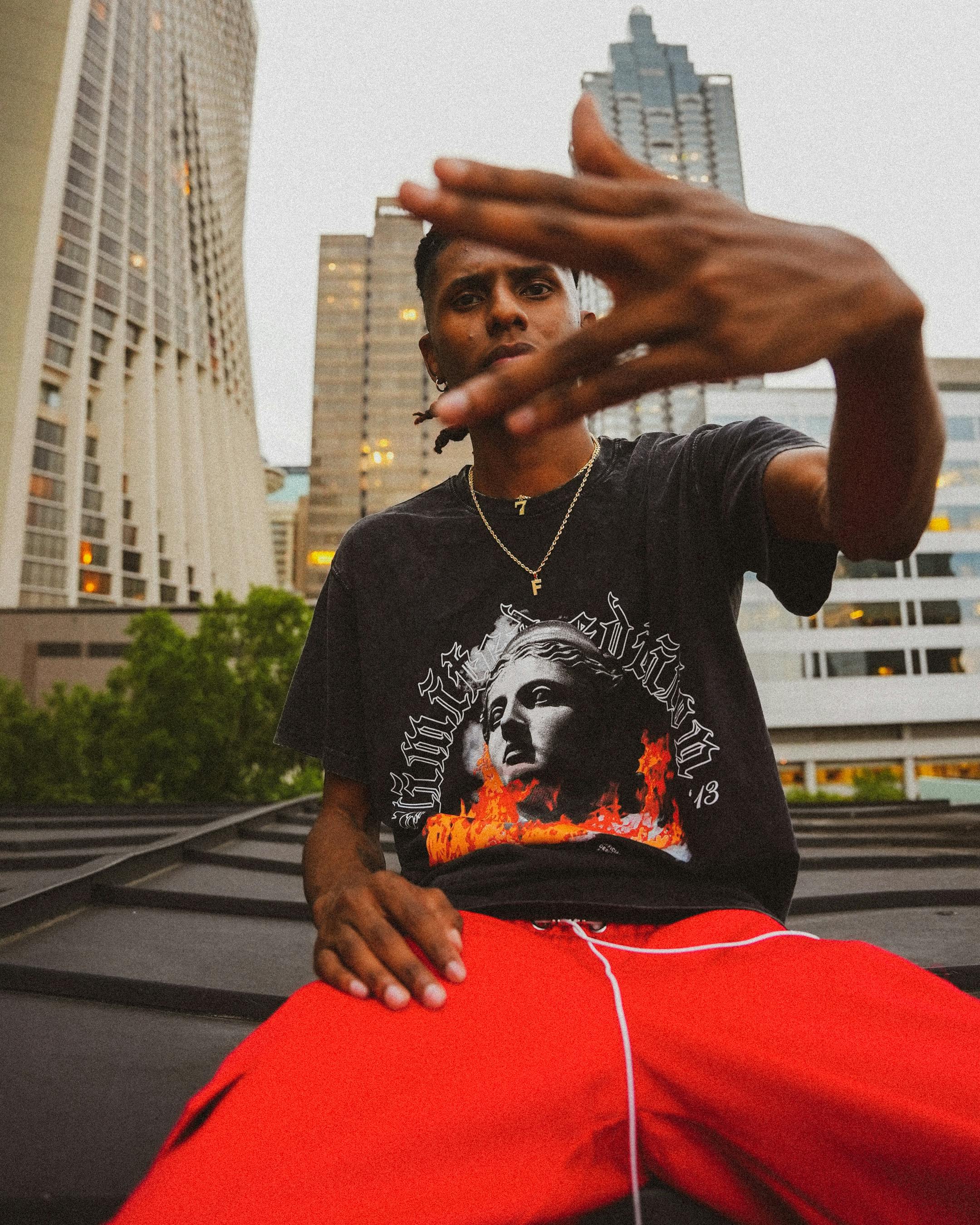 Rapper Wearing Red Trousers, Gesturing against Skyscrapers · Free Stock ...