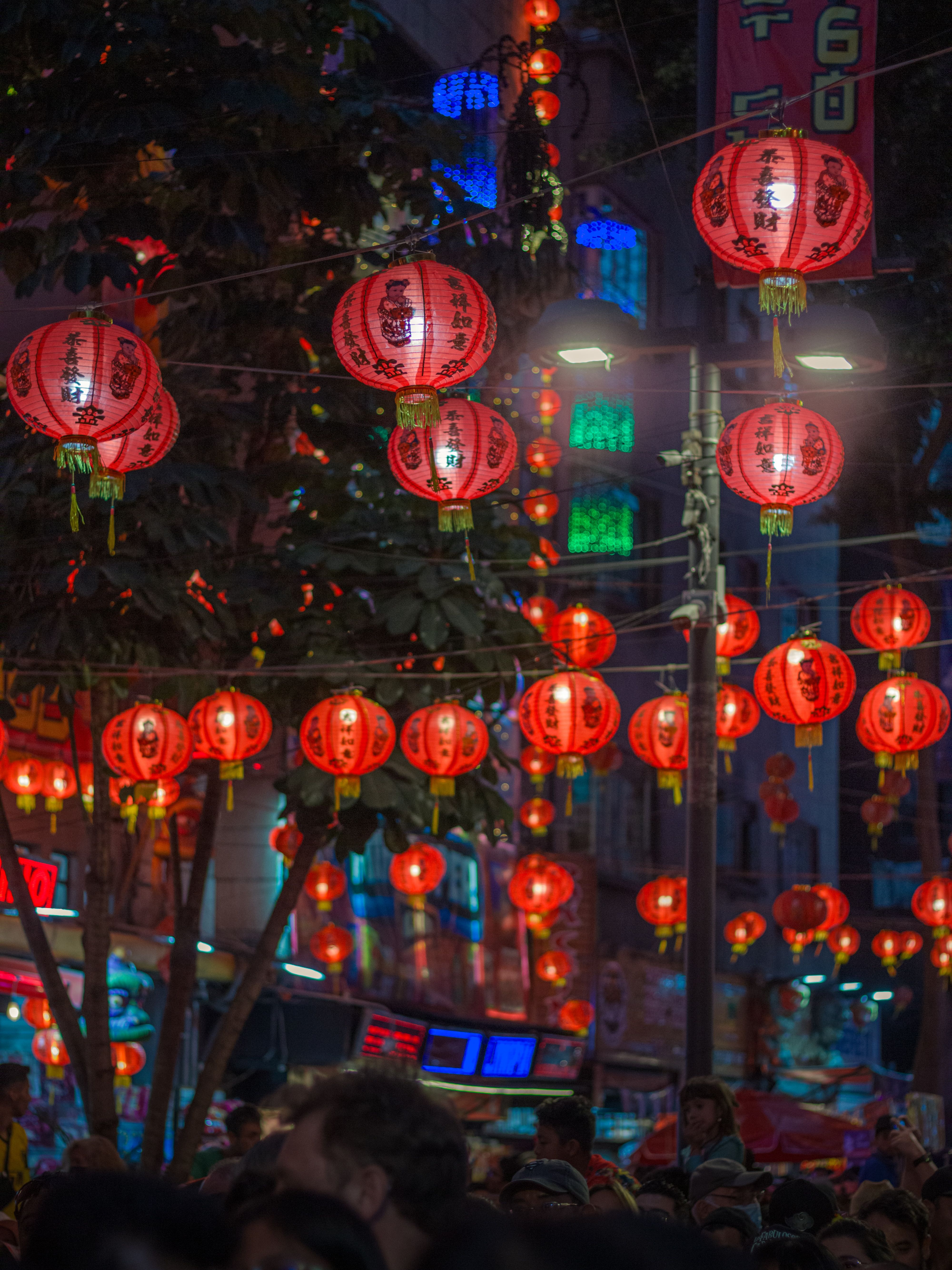 View of Red Paper Lanterns Hanging above a Street · Free Stock Photo