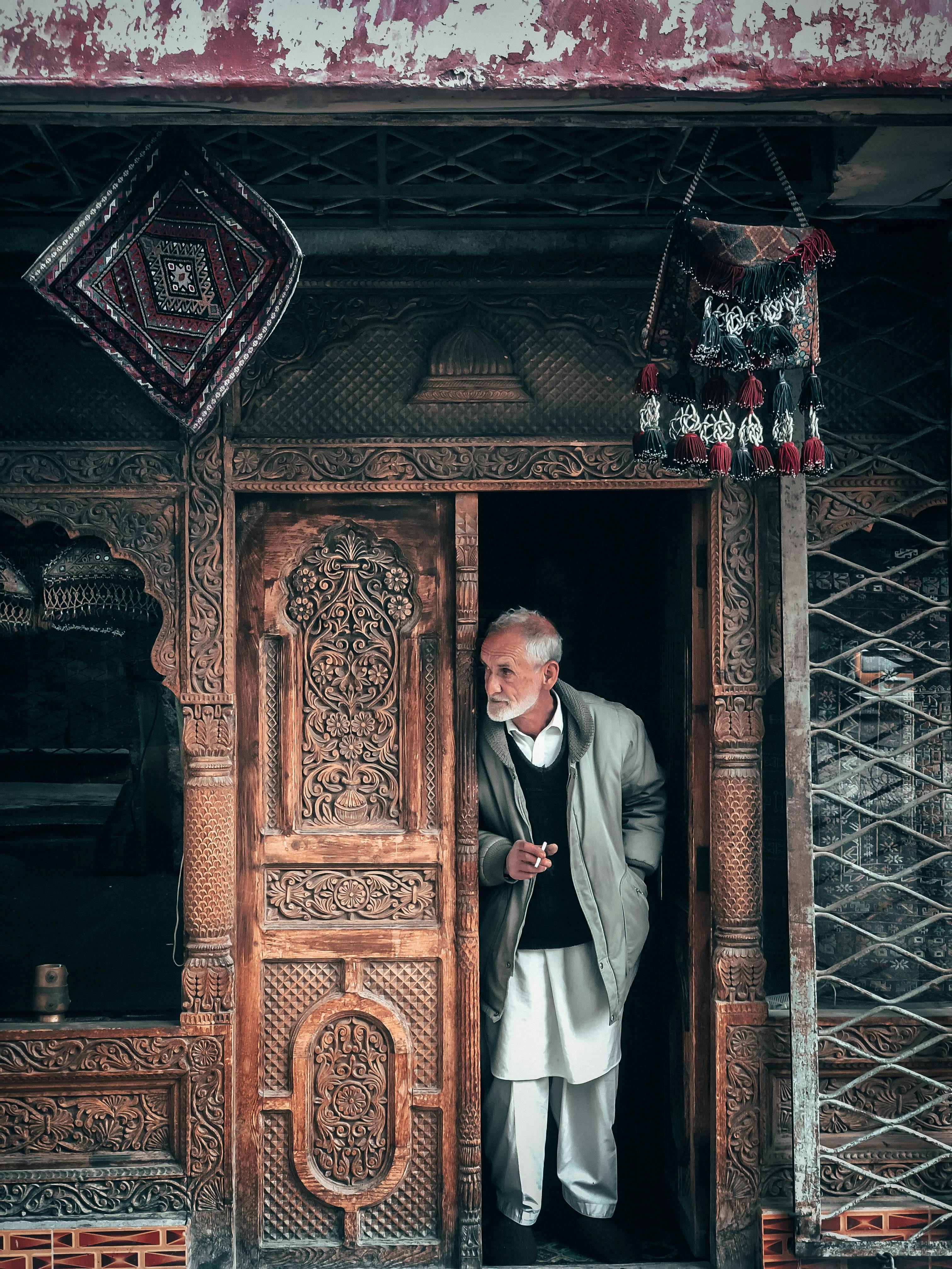 Man Peeking Behind Doors · Free Stock Photo