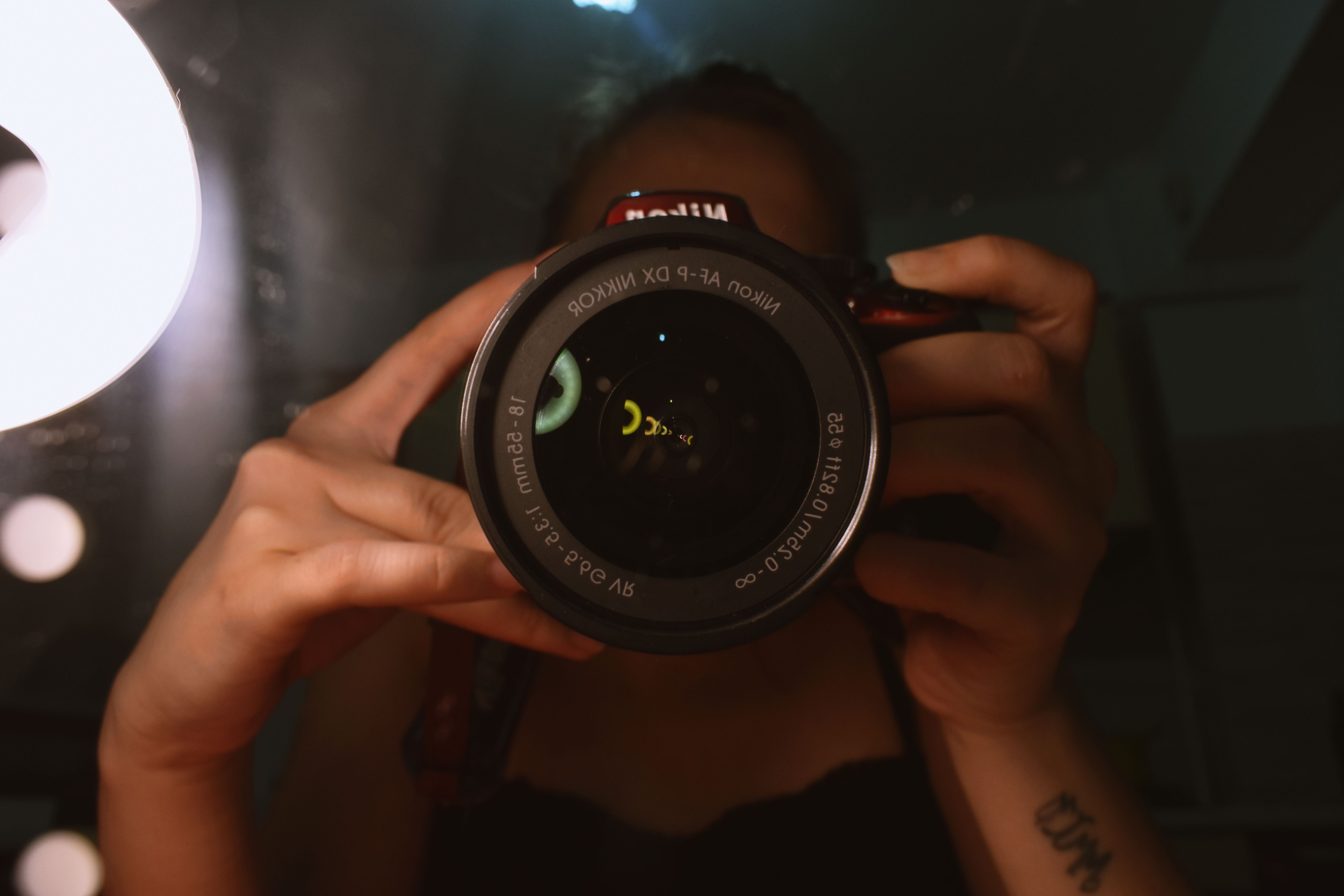 Person Holding Black and Red Dslr Camera With Both Hands · Free Stock Photo