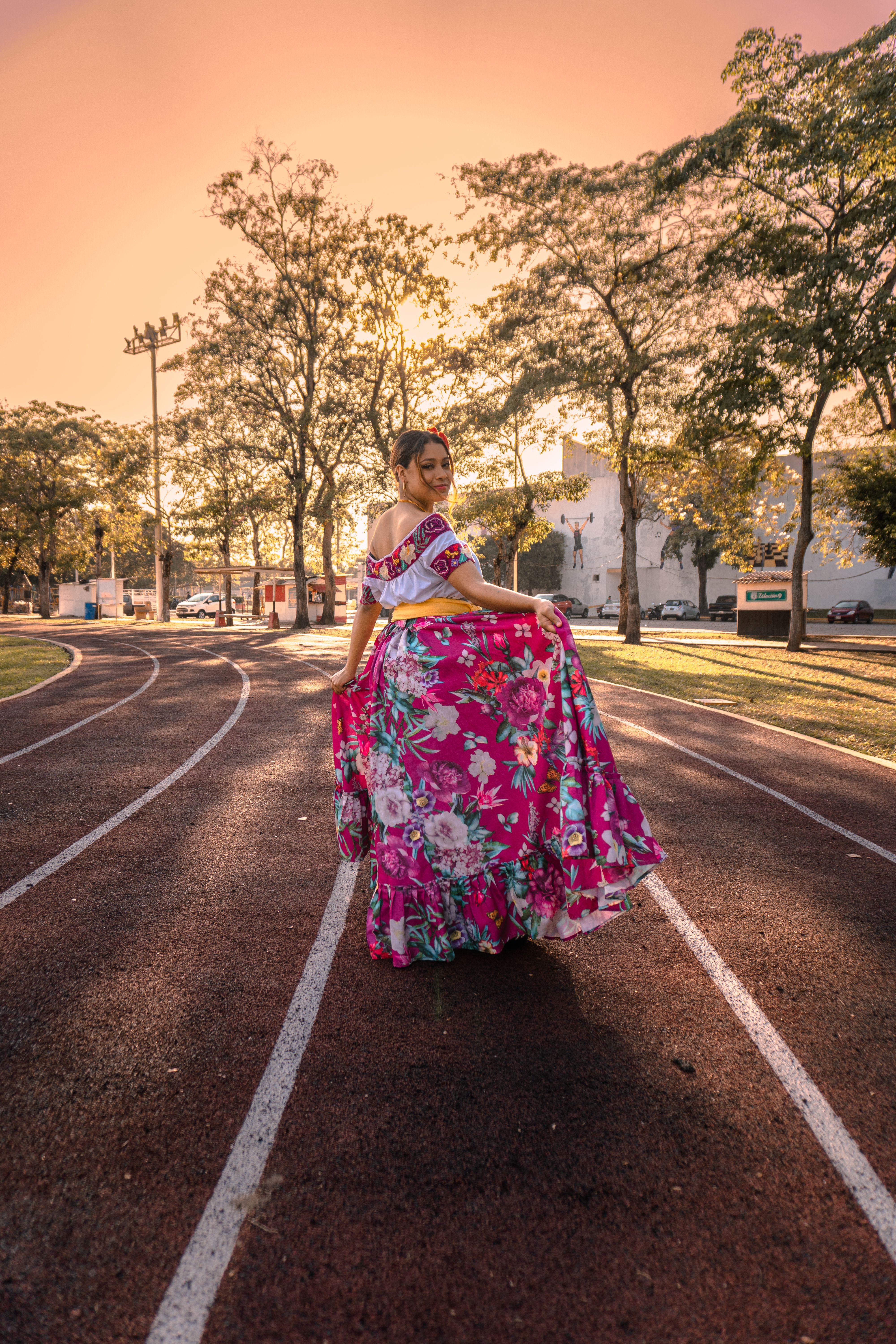 Woman in Folk Dress Posing on Running Track · Free Stock Photo