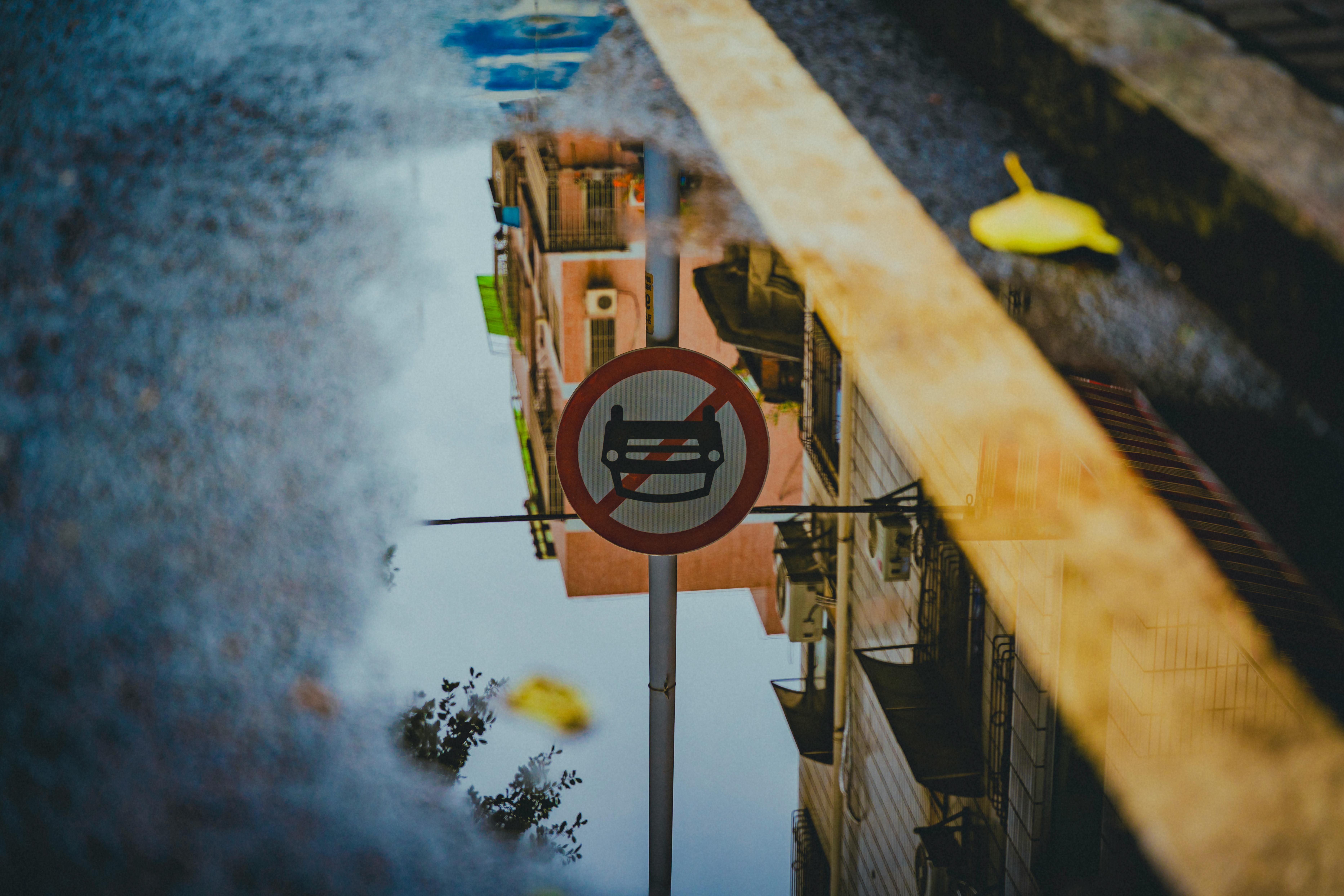 Road Sign Upside Down in Reflection in Water · Free Stock Photo