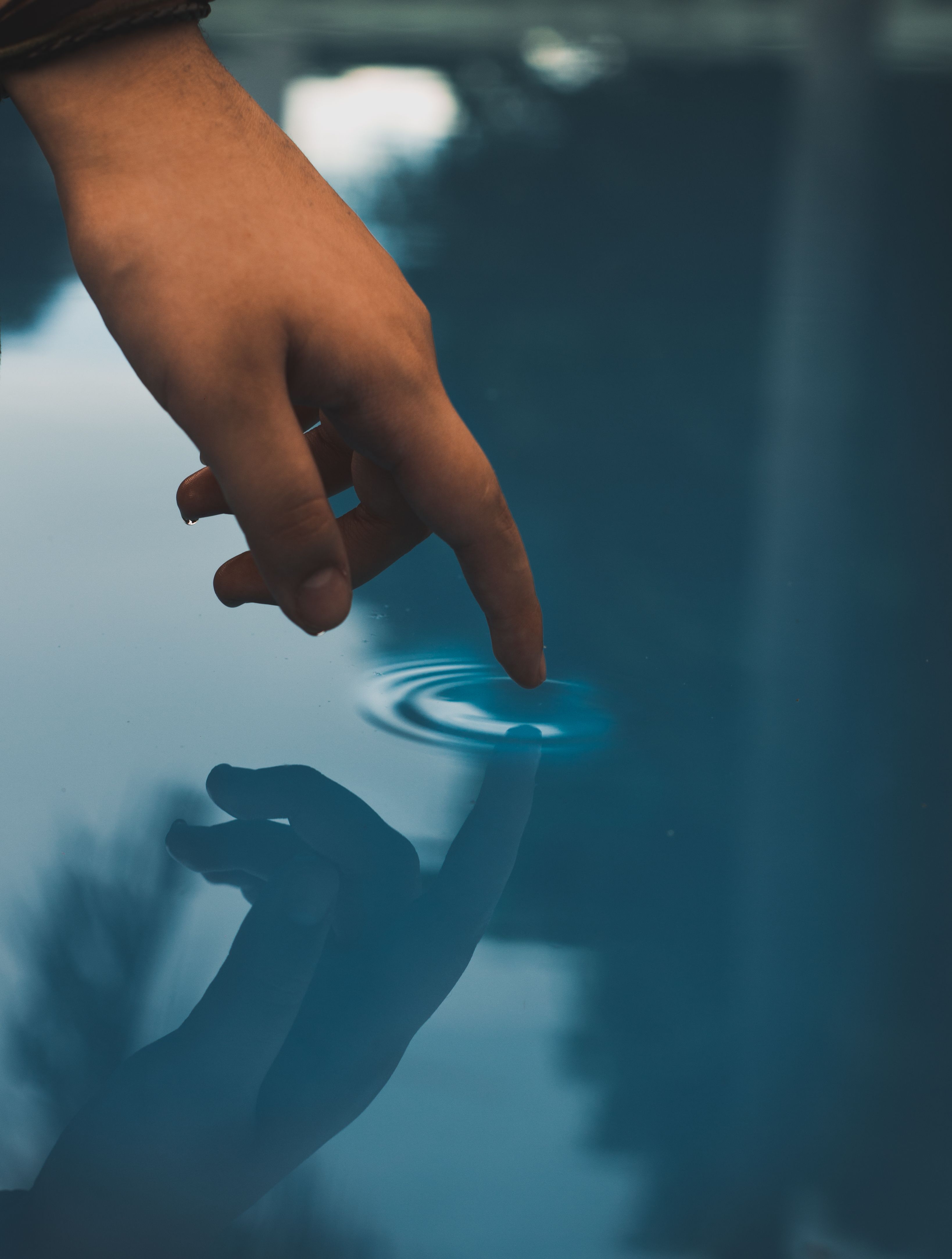 Person Touching Pool Of Water · Free Stock Photo