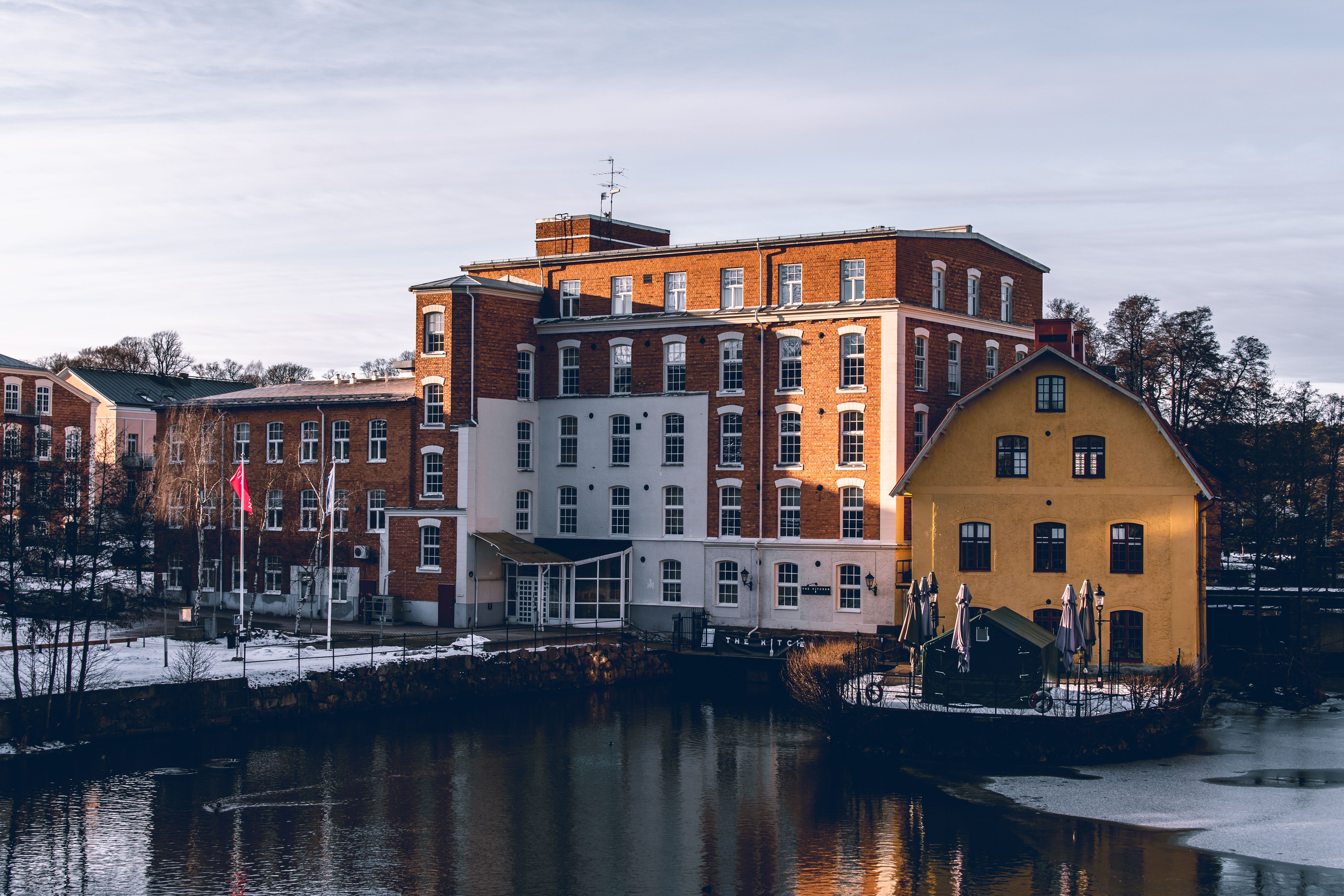Architectural Photography of Brown and White Building Near Body of ...