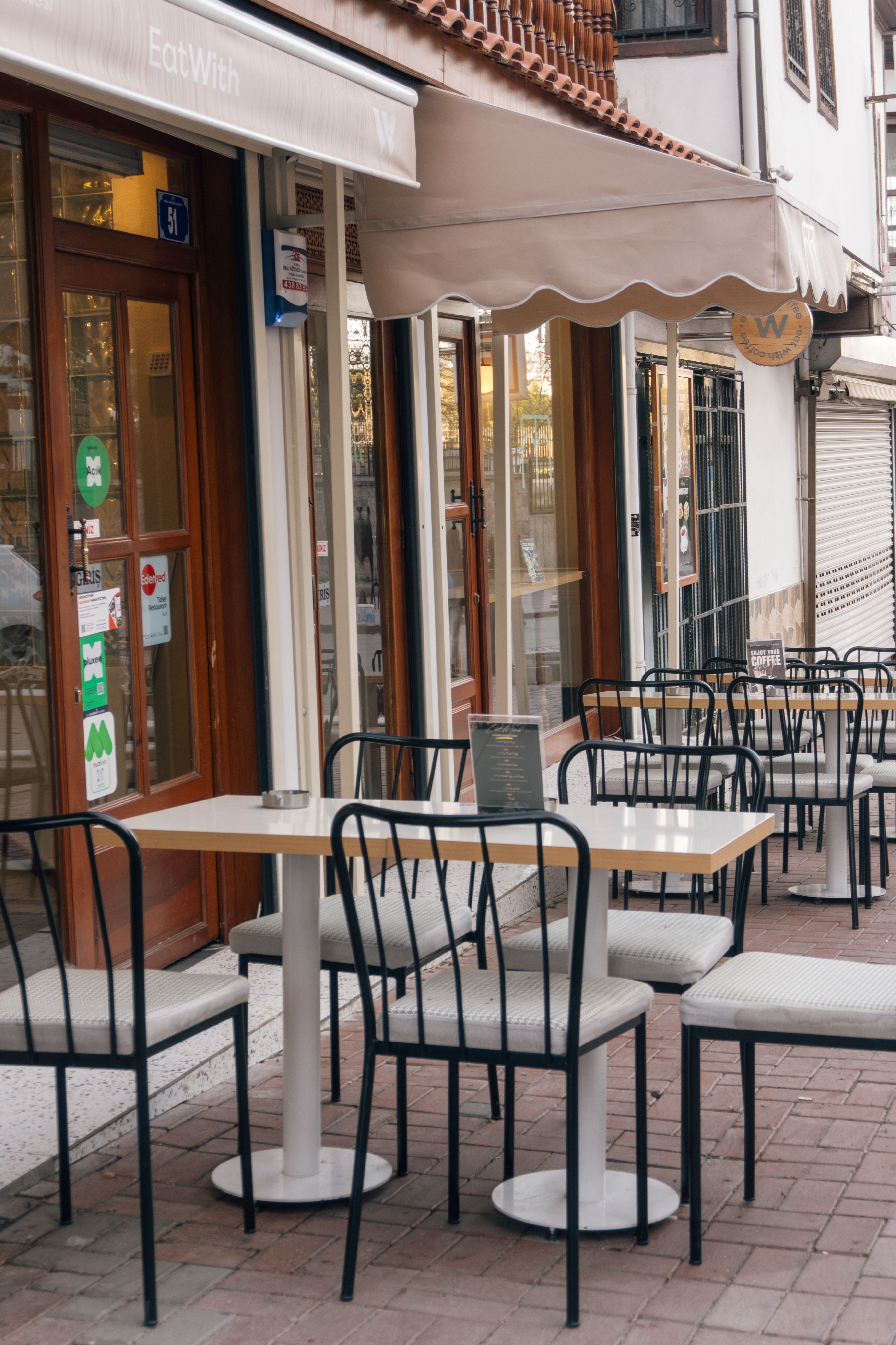 Empty tables with chairs of sidewalk cafe · Free Stock Photo