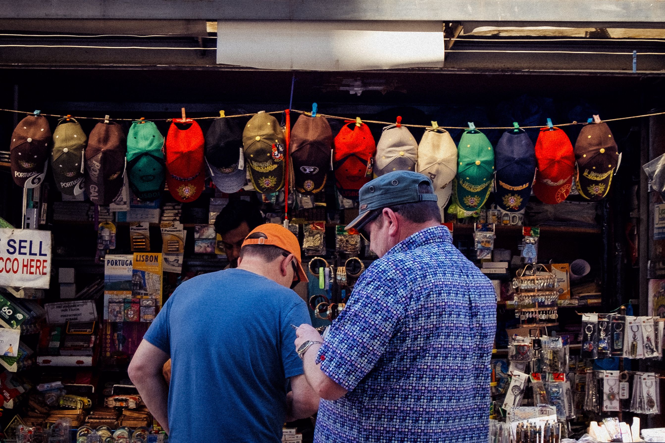 Two people with hats at a souvenir shop · Free Stock Photo