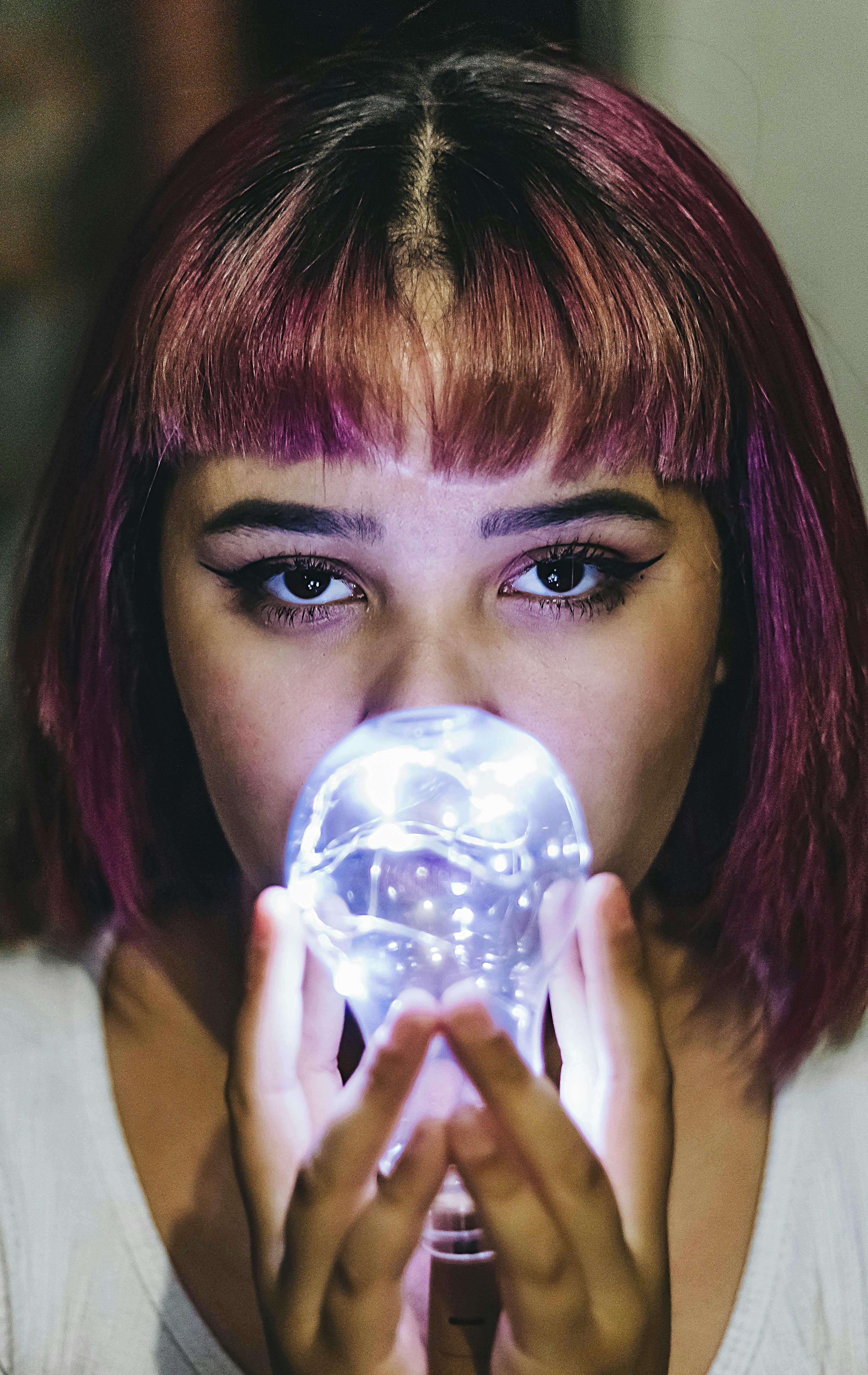 Close-Up Photo of Woman Holding Light Bulb · Free Stock Photo