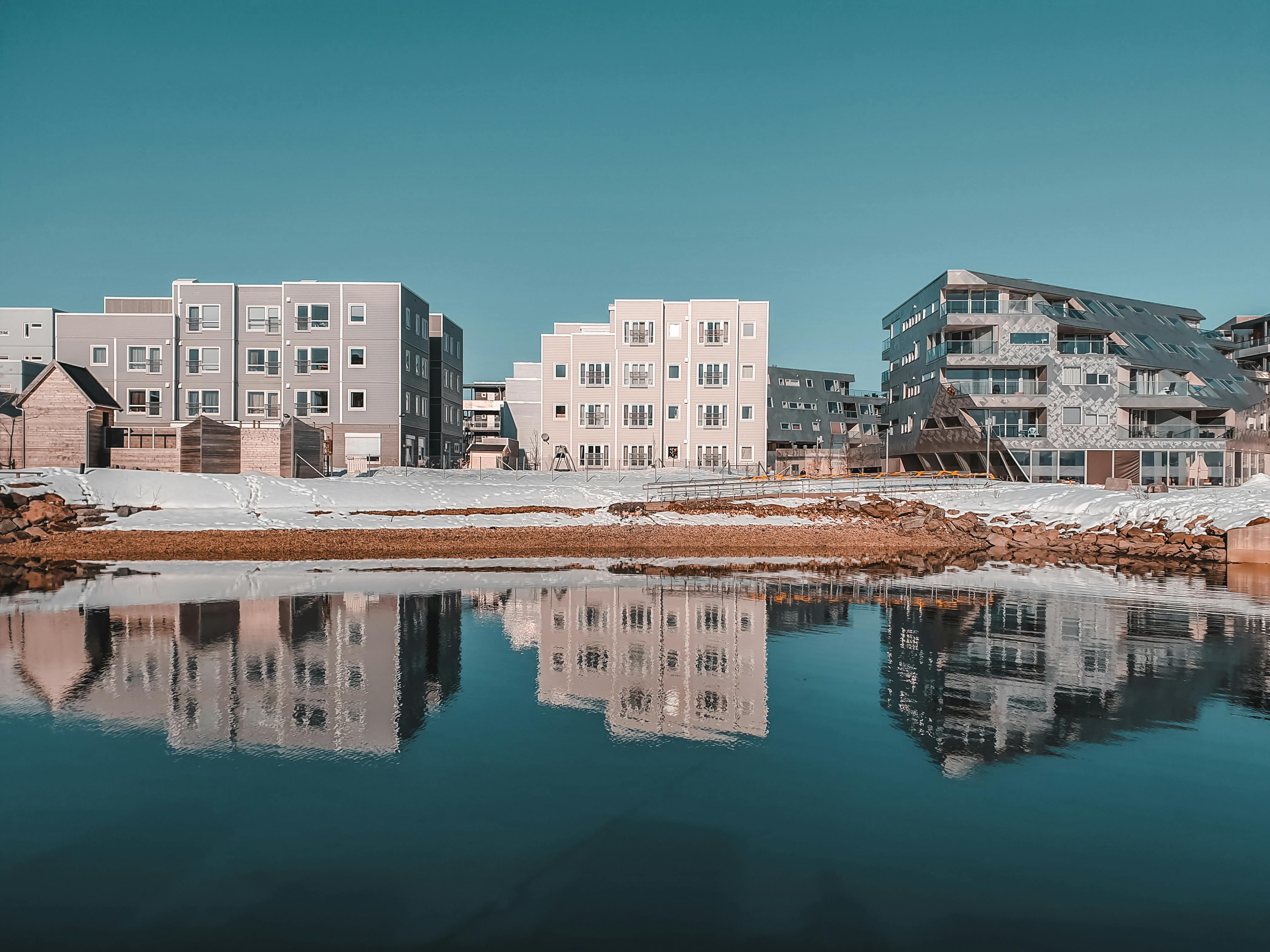 Concrete Building Near Body Of Water · Free Stock Photo