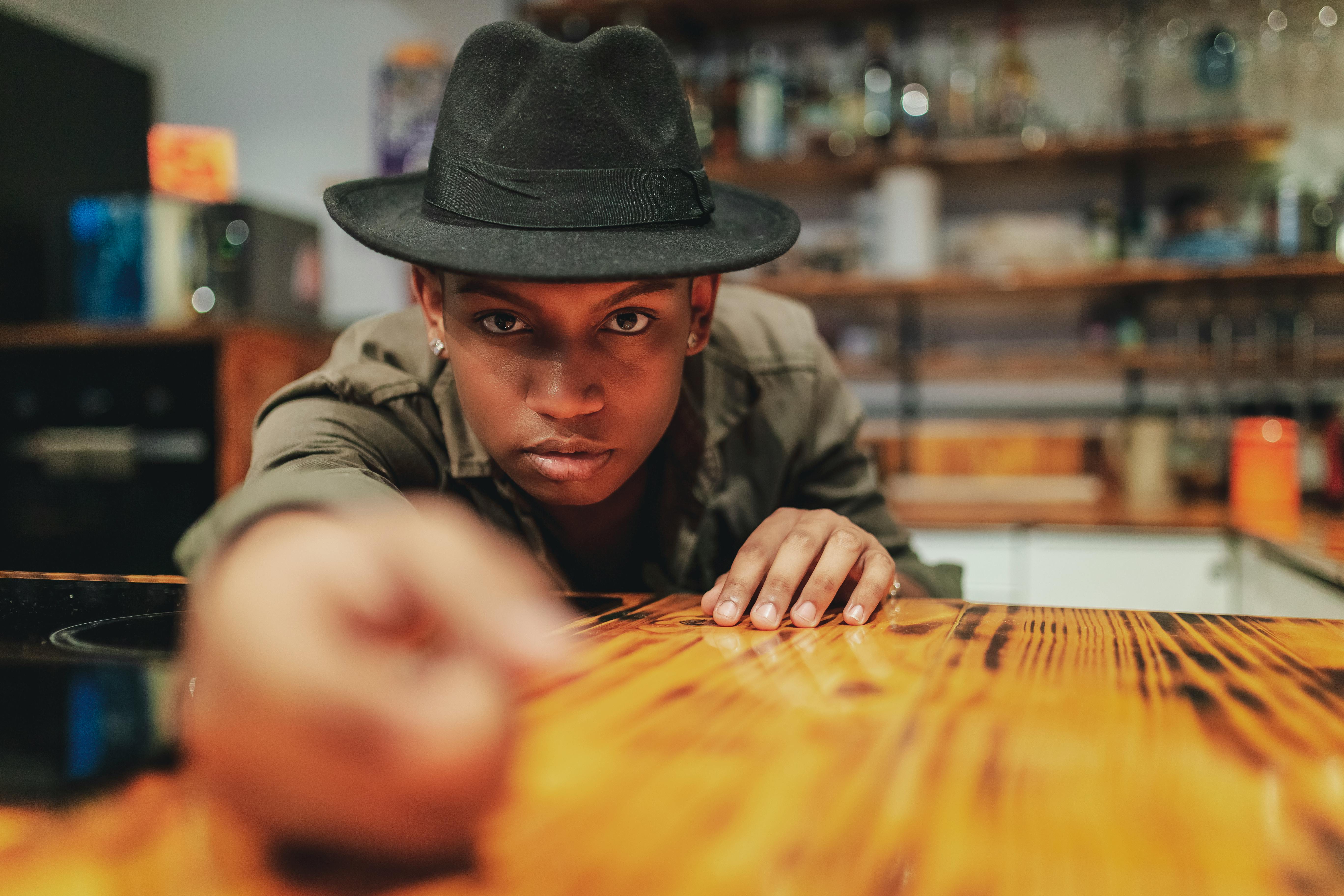 Man Leaning on Wooden Table · Free Stock Photo
