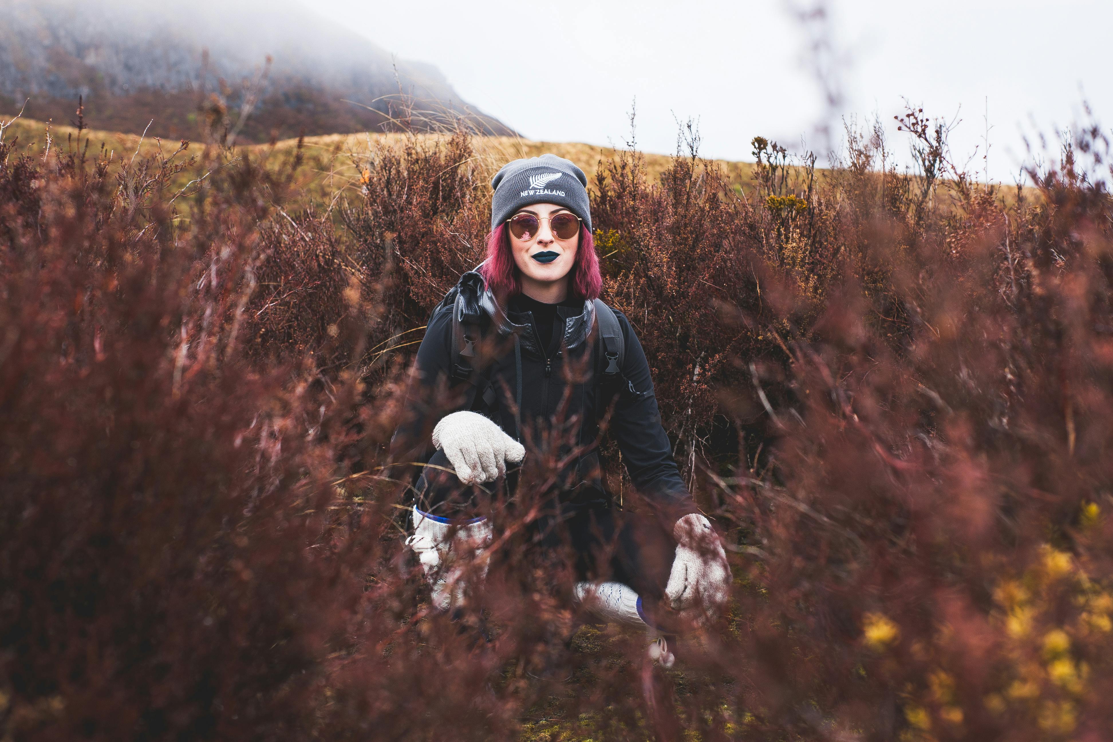Photo of Woman With Purple Hair Squat Posing in the Middle of Bushes ...