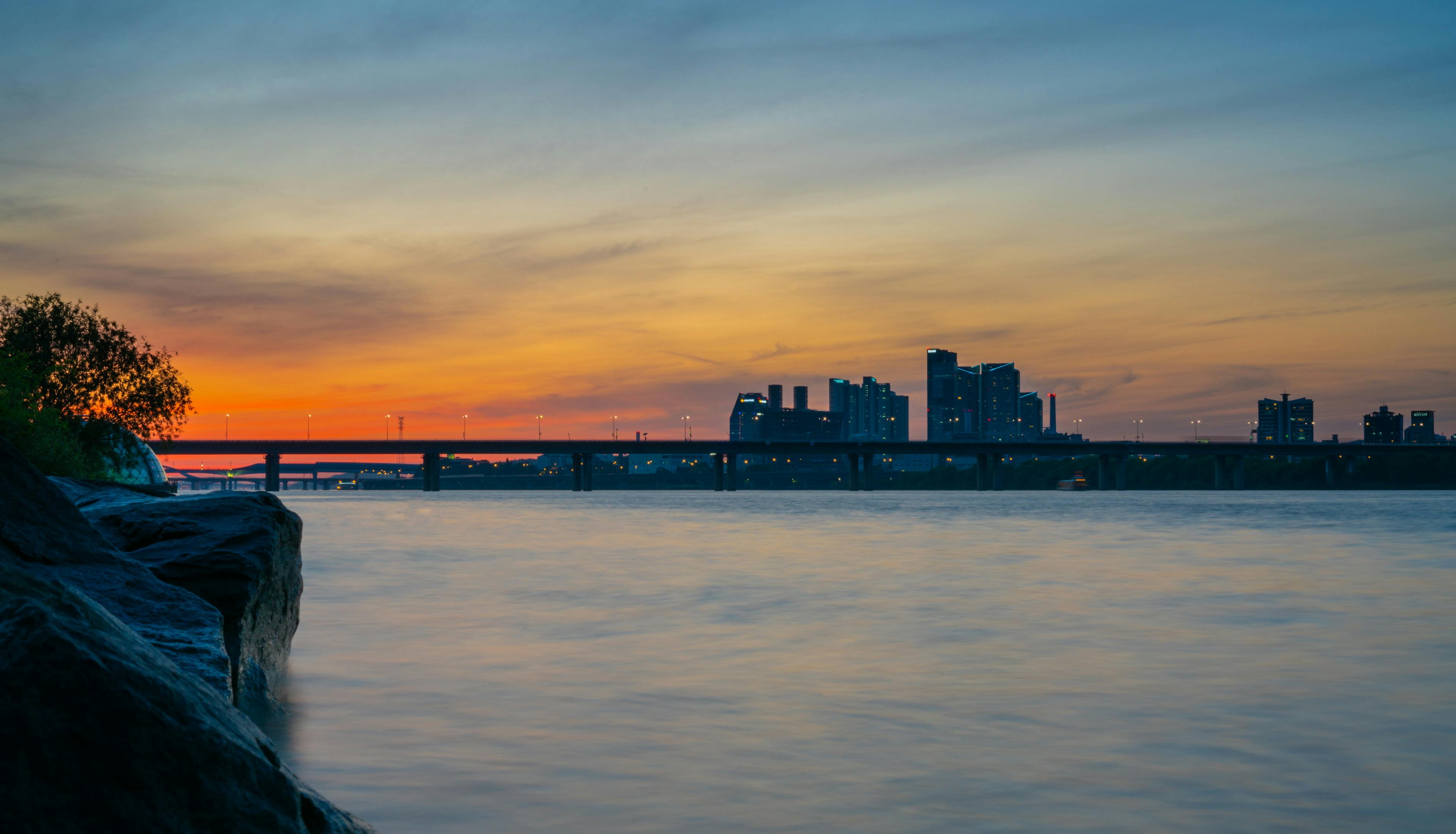 White Building Surrounded by Water and Trees during Golden Hour · Free ...