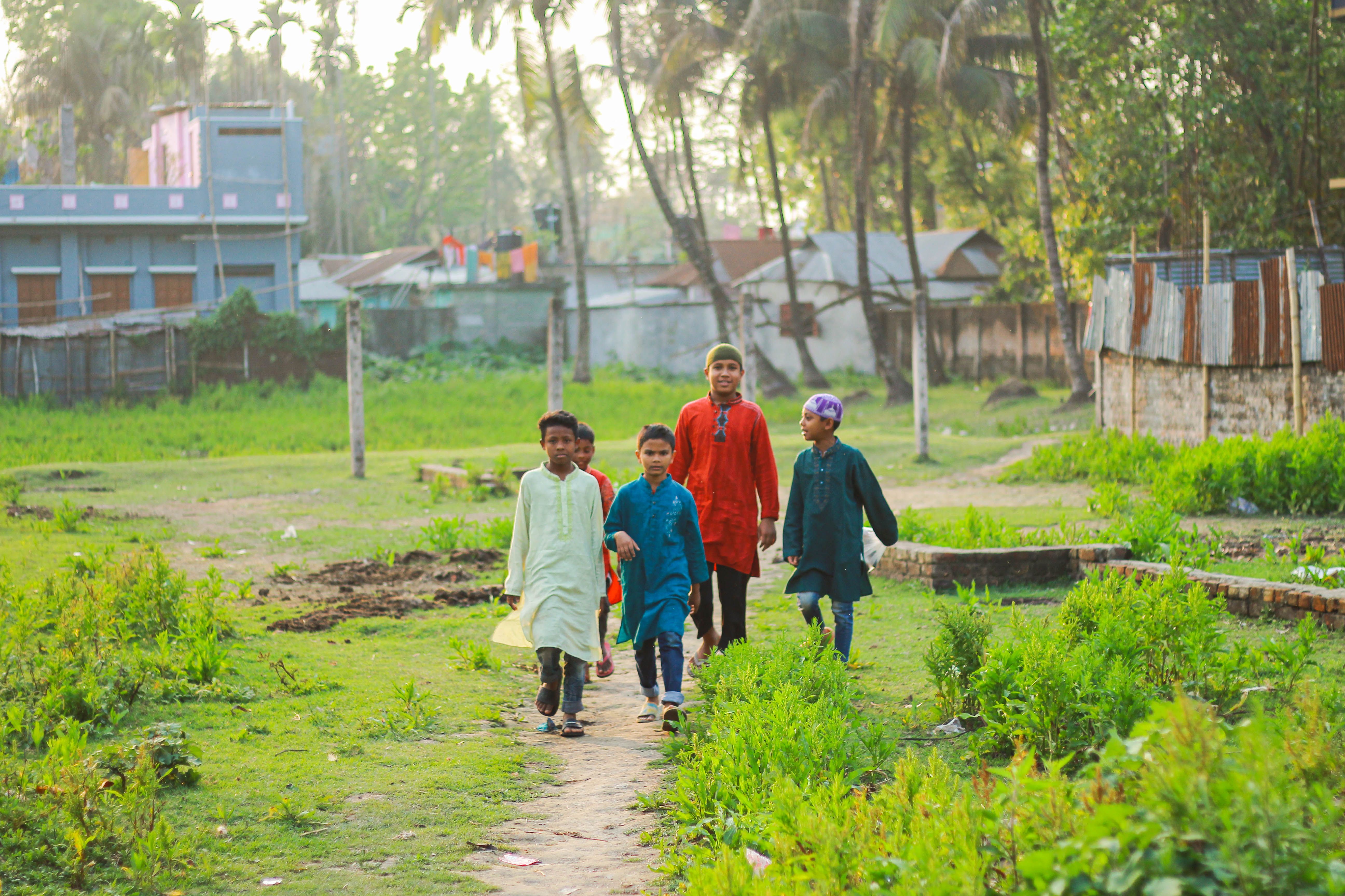 Group of Boys in Gowns on Footpath · Free Stock Photo
