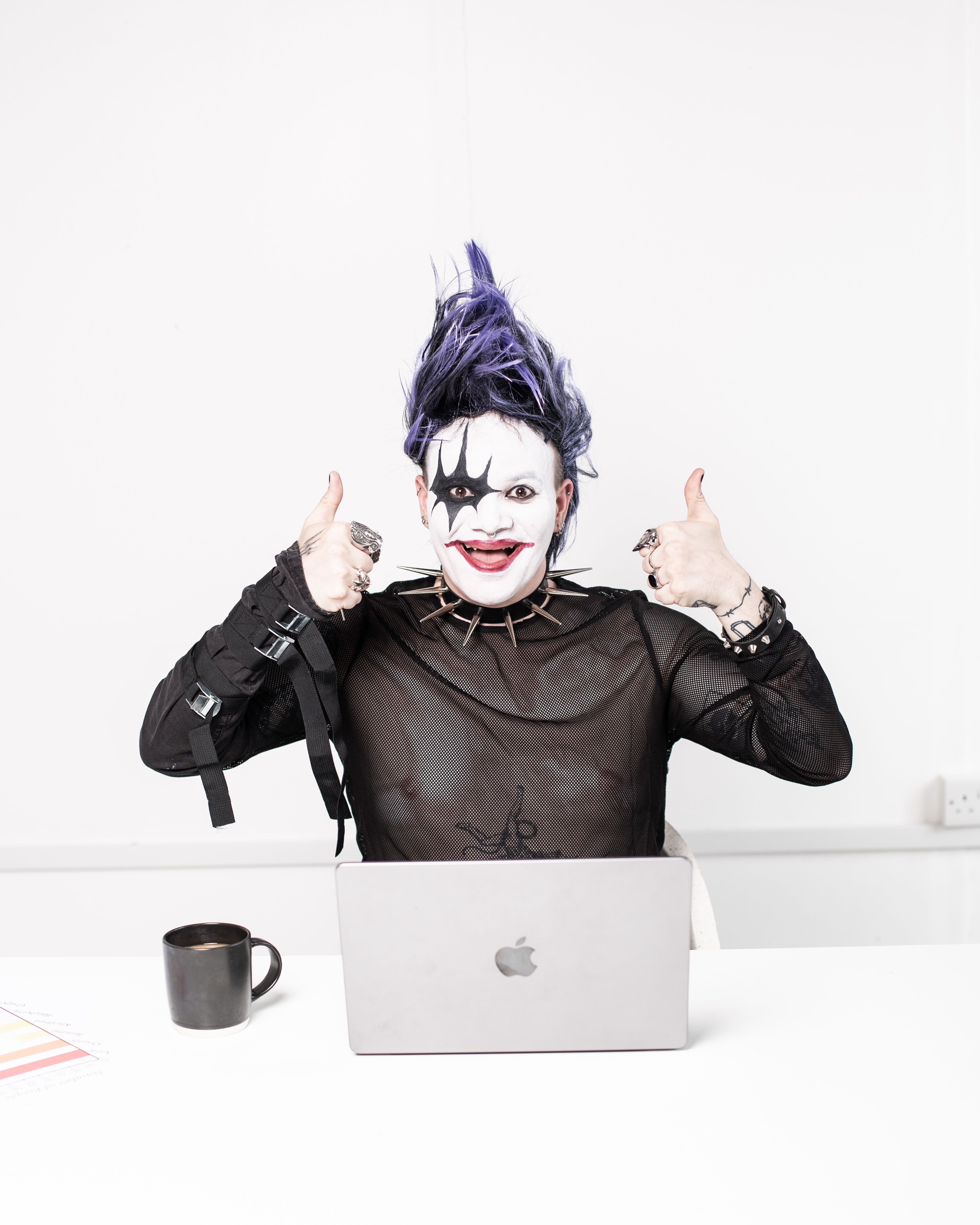 Smiling Man Working on Laptop in Joker Costume · Free Stock Photo