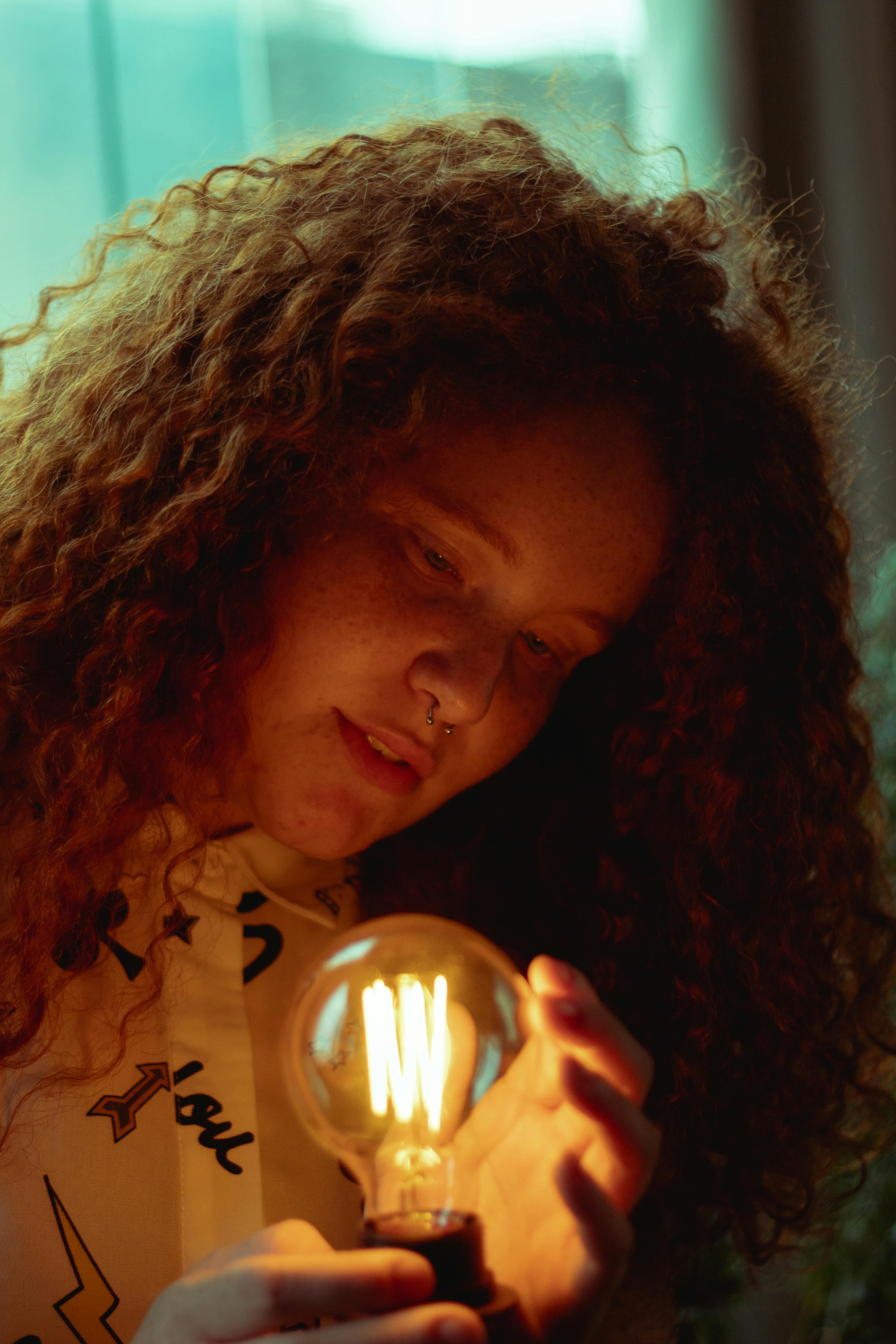 Woman Holding Lighted Led Bulb · Free Stock Photo