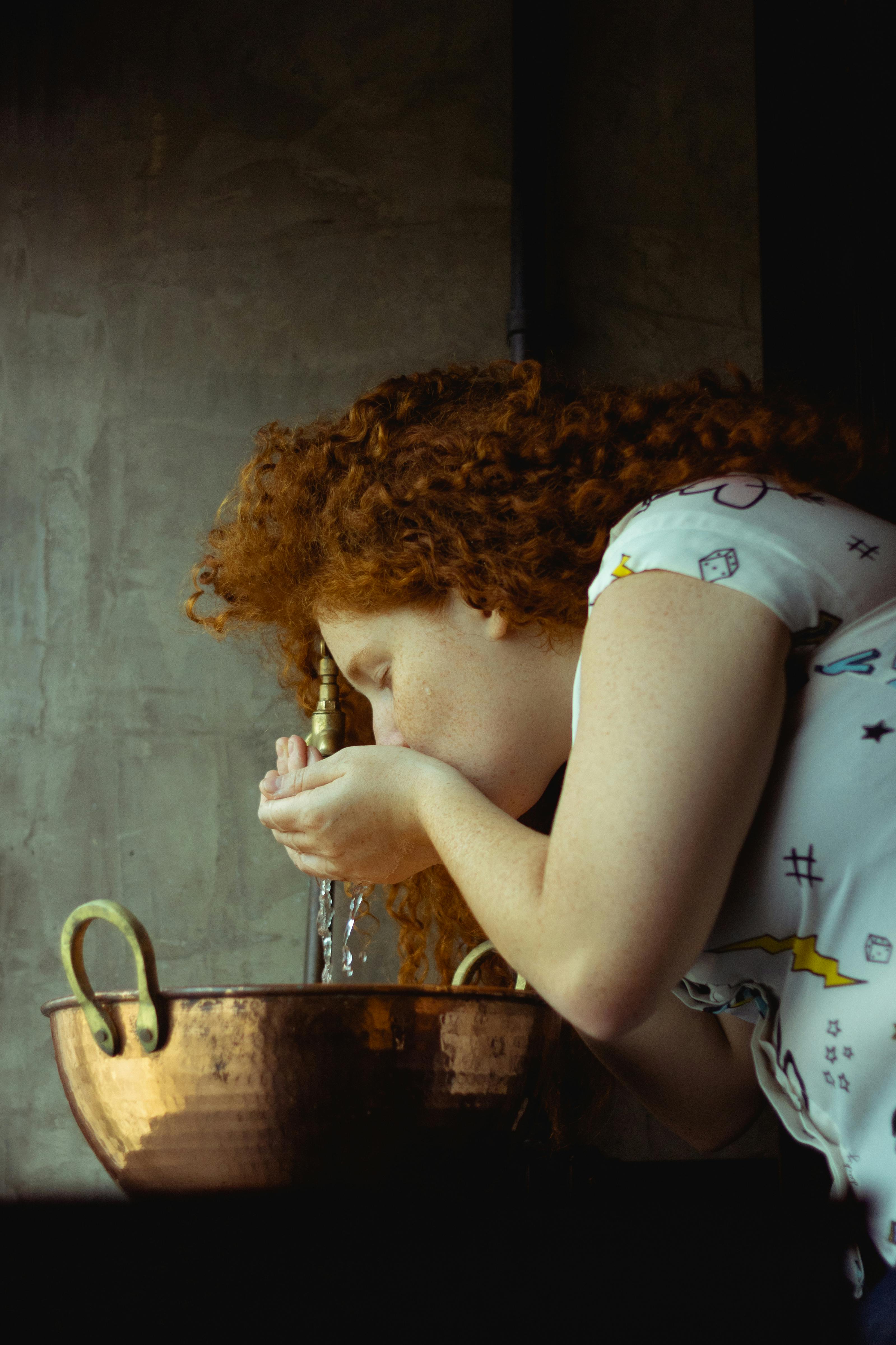 Woman Drinking Water From Faucet · Free Stock Photo