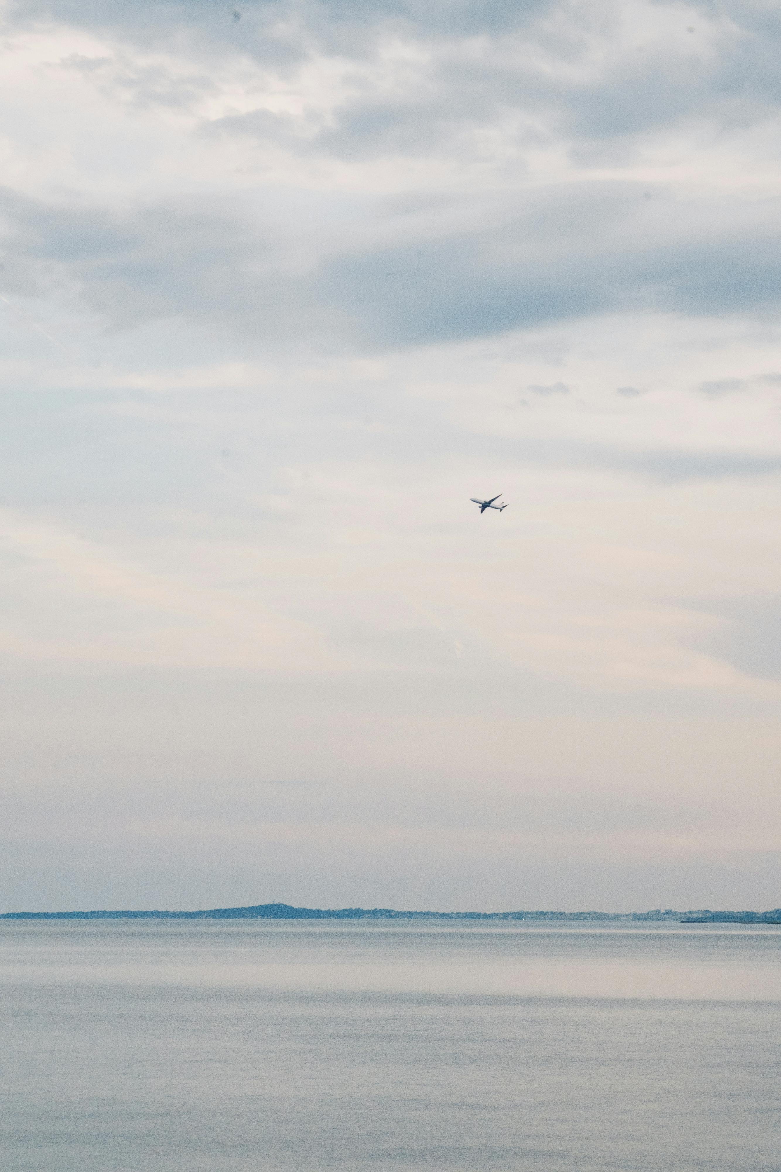 Airplane Flying over Sea · Free Stock Photo