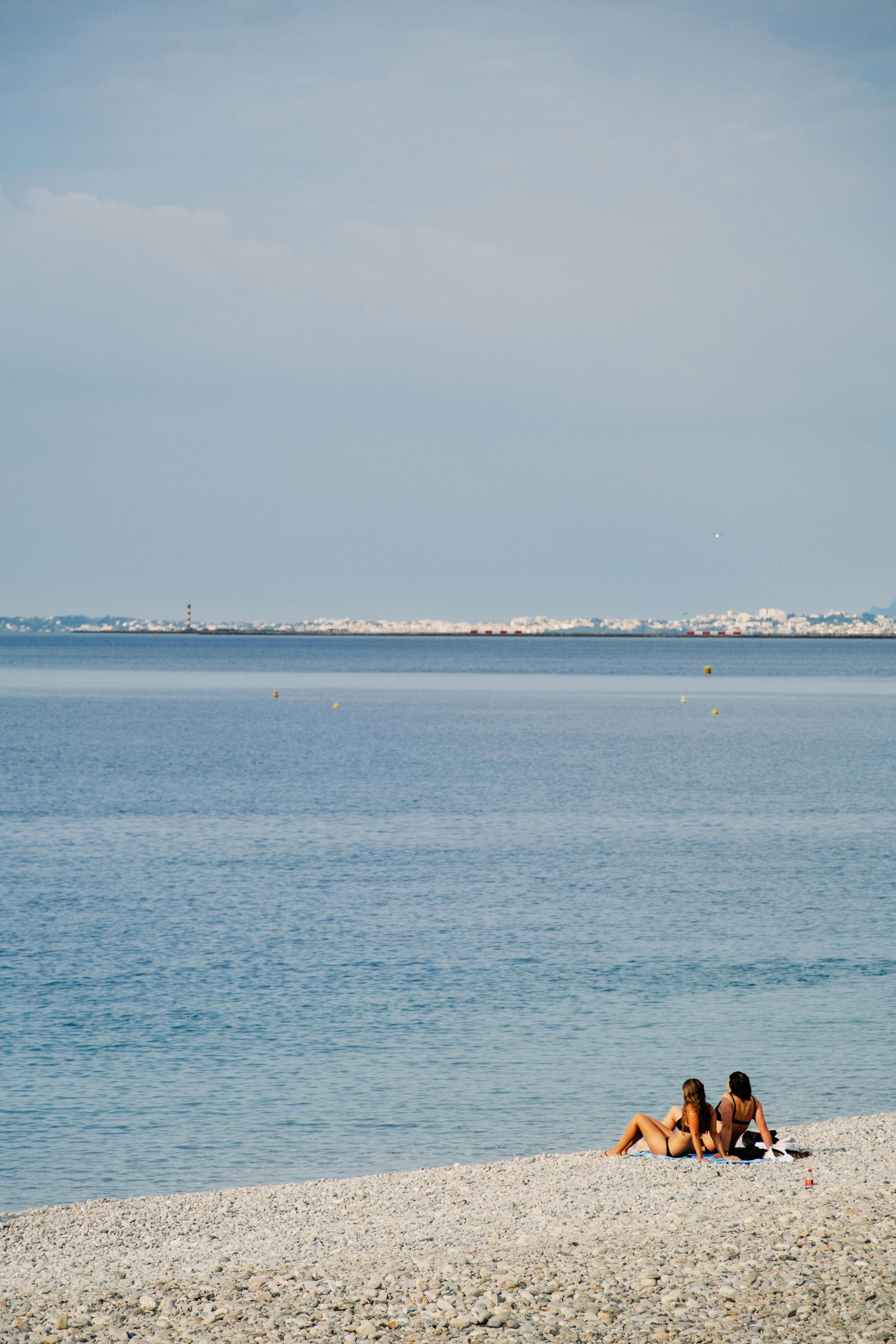 Women Sunbathing on Beach · Free Stock Photo