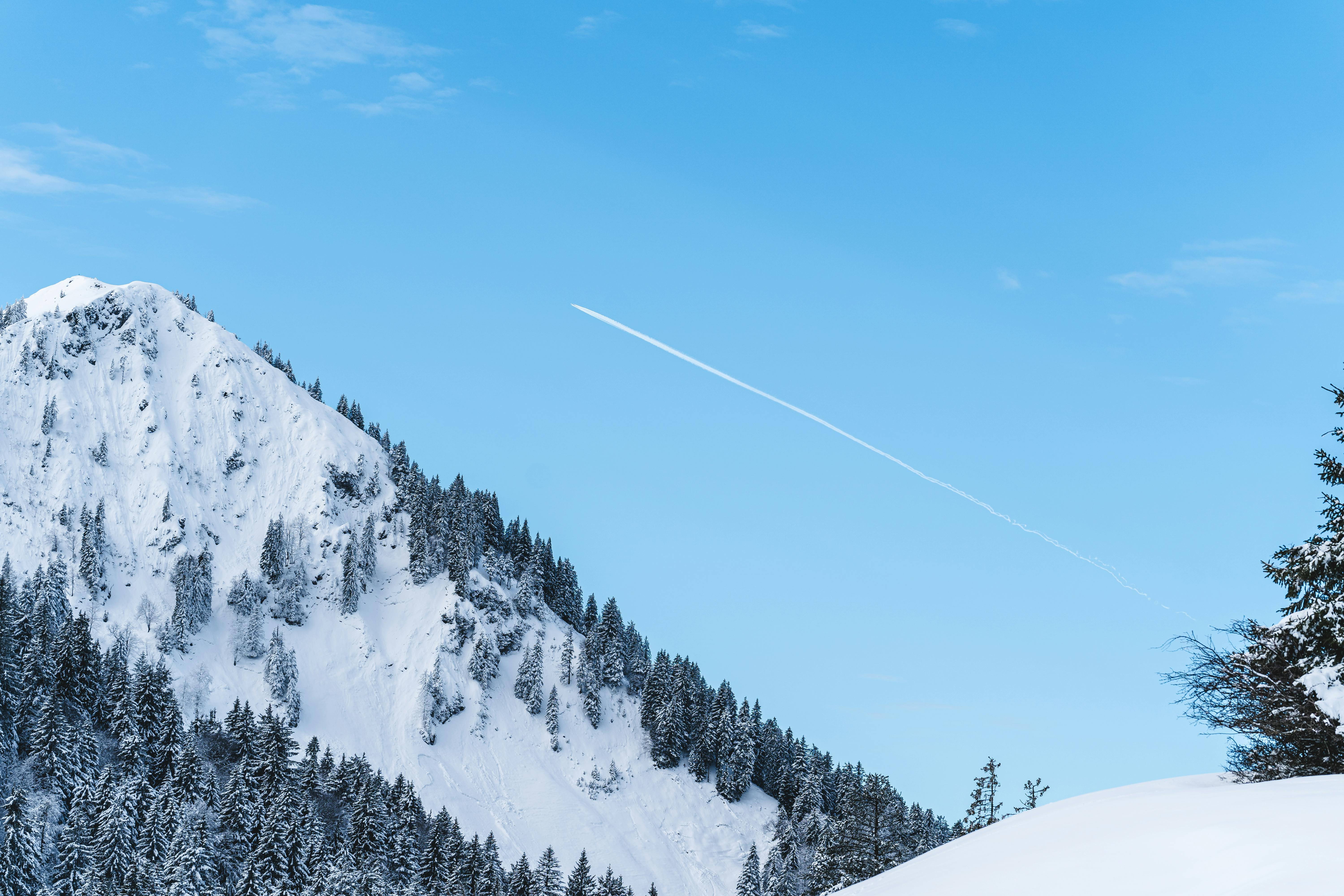 Contrail over Mountain in Snow · Free Stock Photo