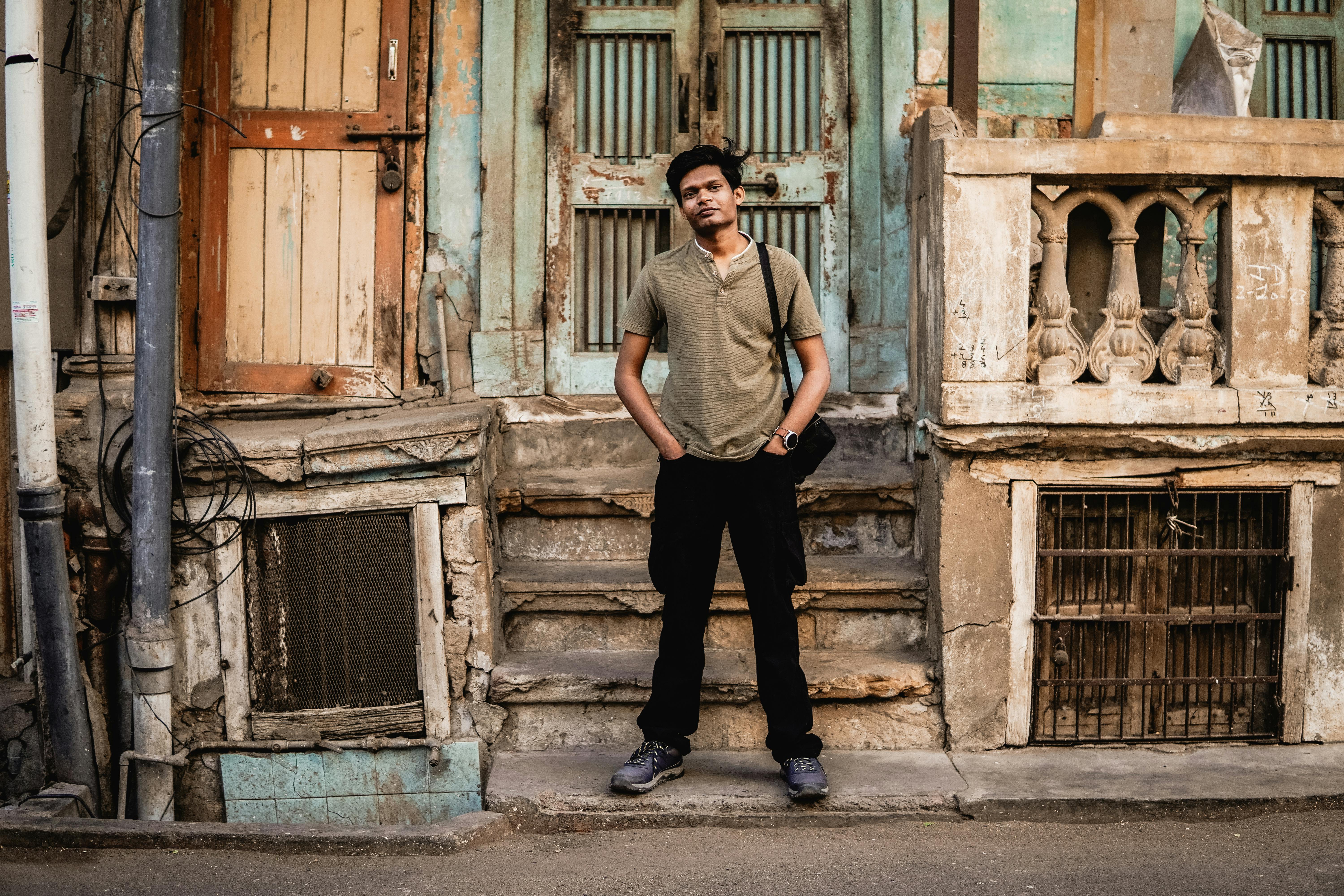A Man Standing in Front of an Abandoned Building · Free Stock Photo