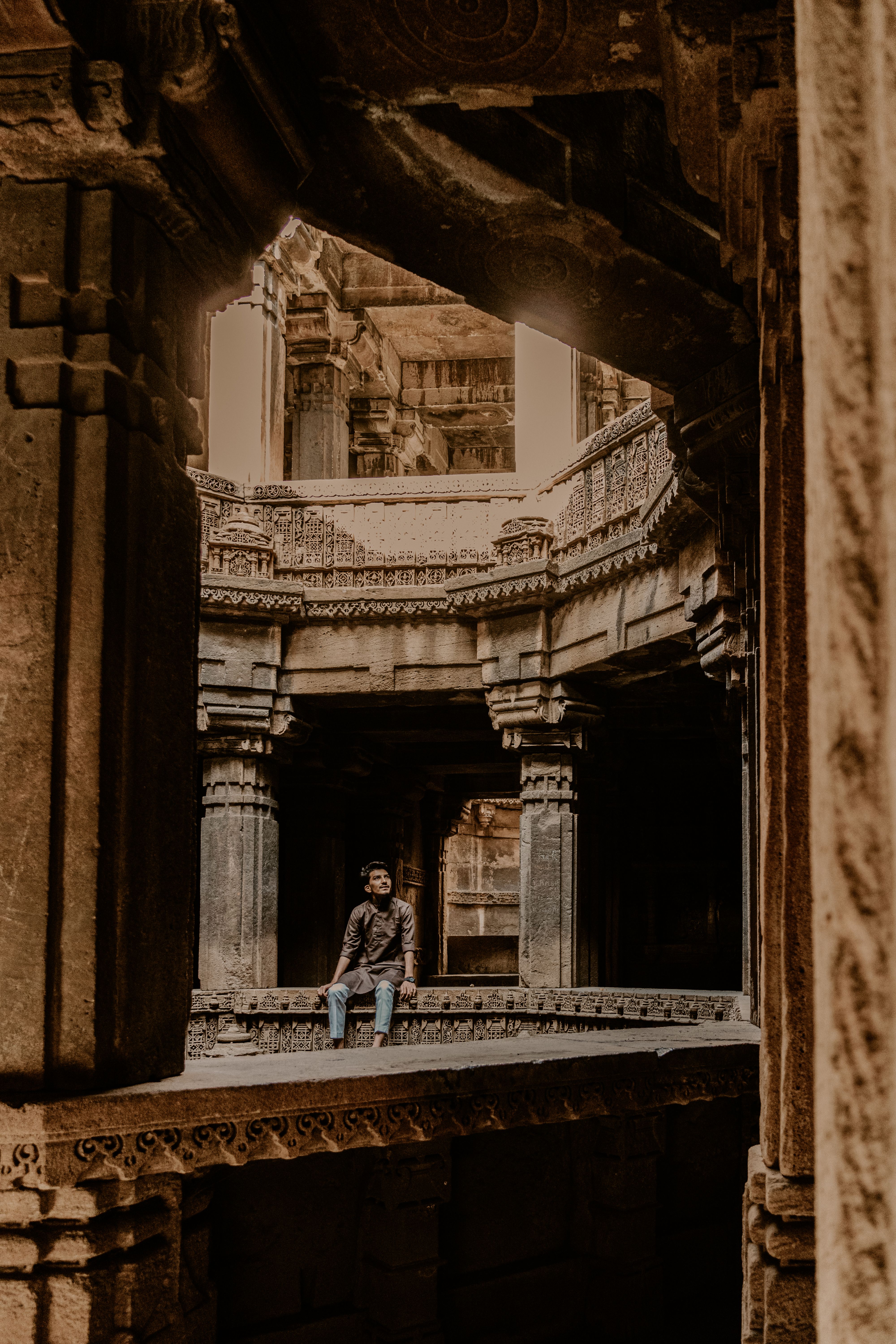 A Man Sitting Inside the Dada Harir Stepwell in Asarwa, India · Free ...