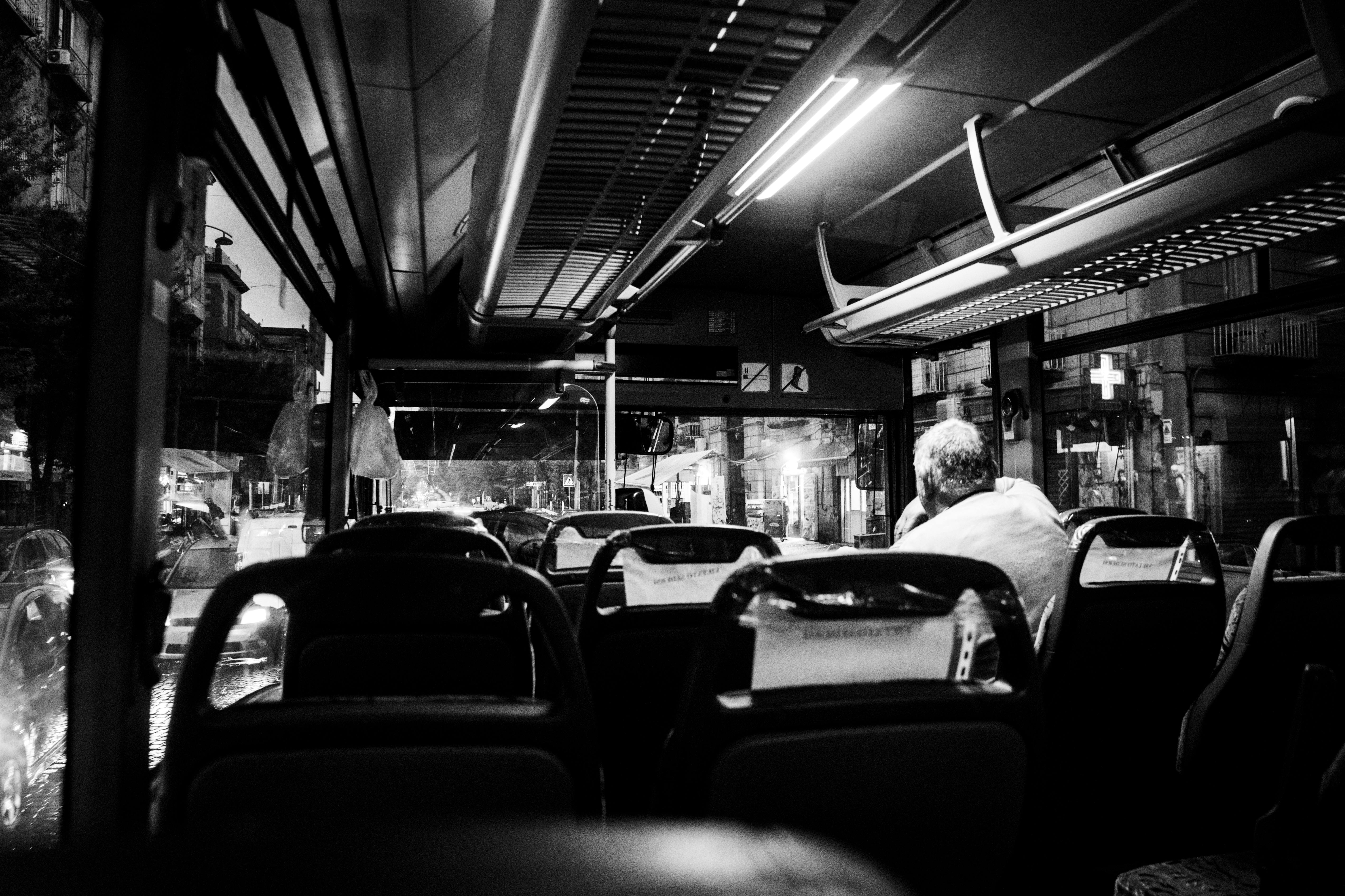 Man Sitting on Bus in Black and White · Free Stock Photo