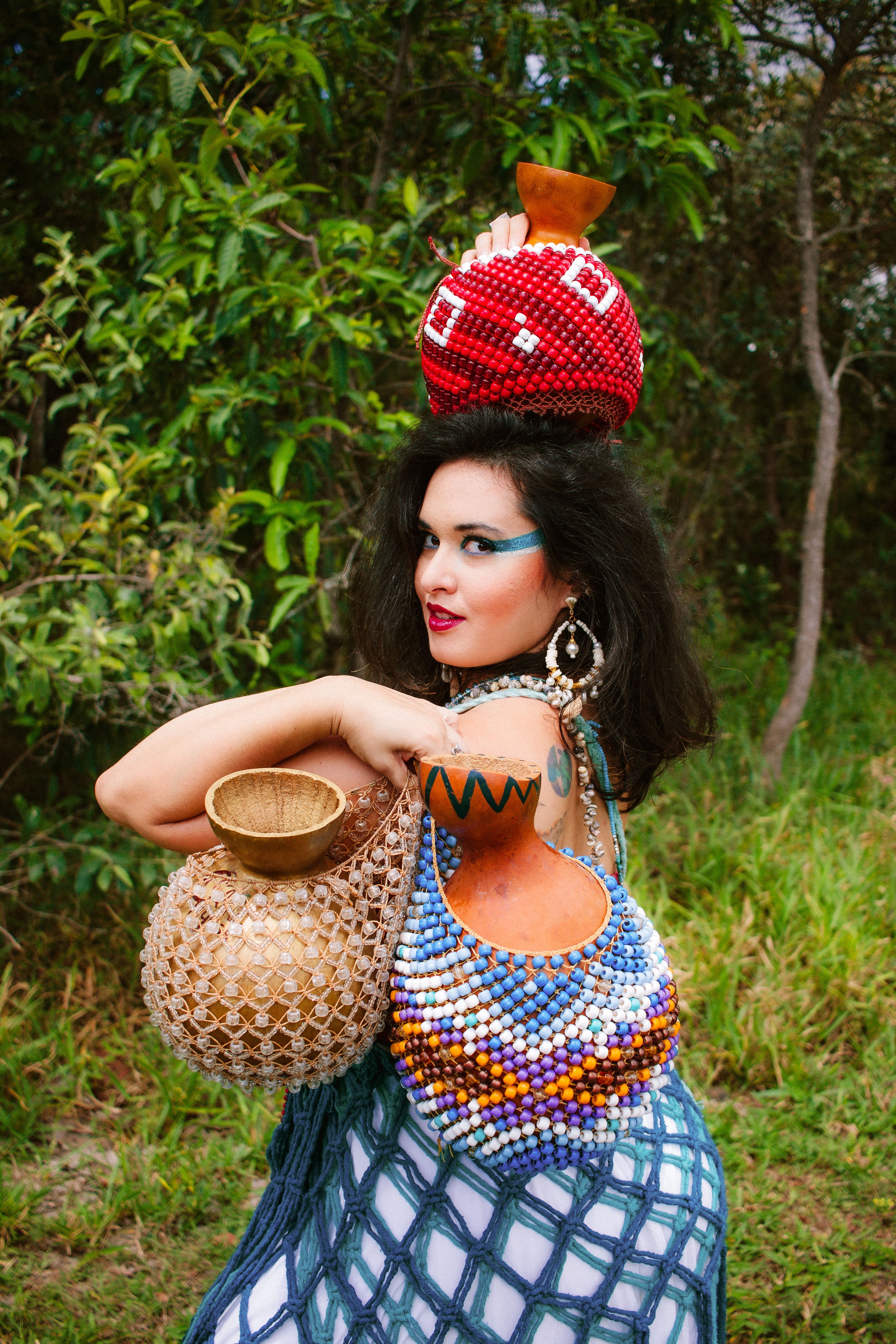 Brunette Woman Holding Vases with Beads · Free Stock Photo