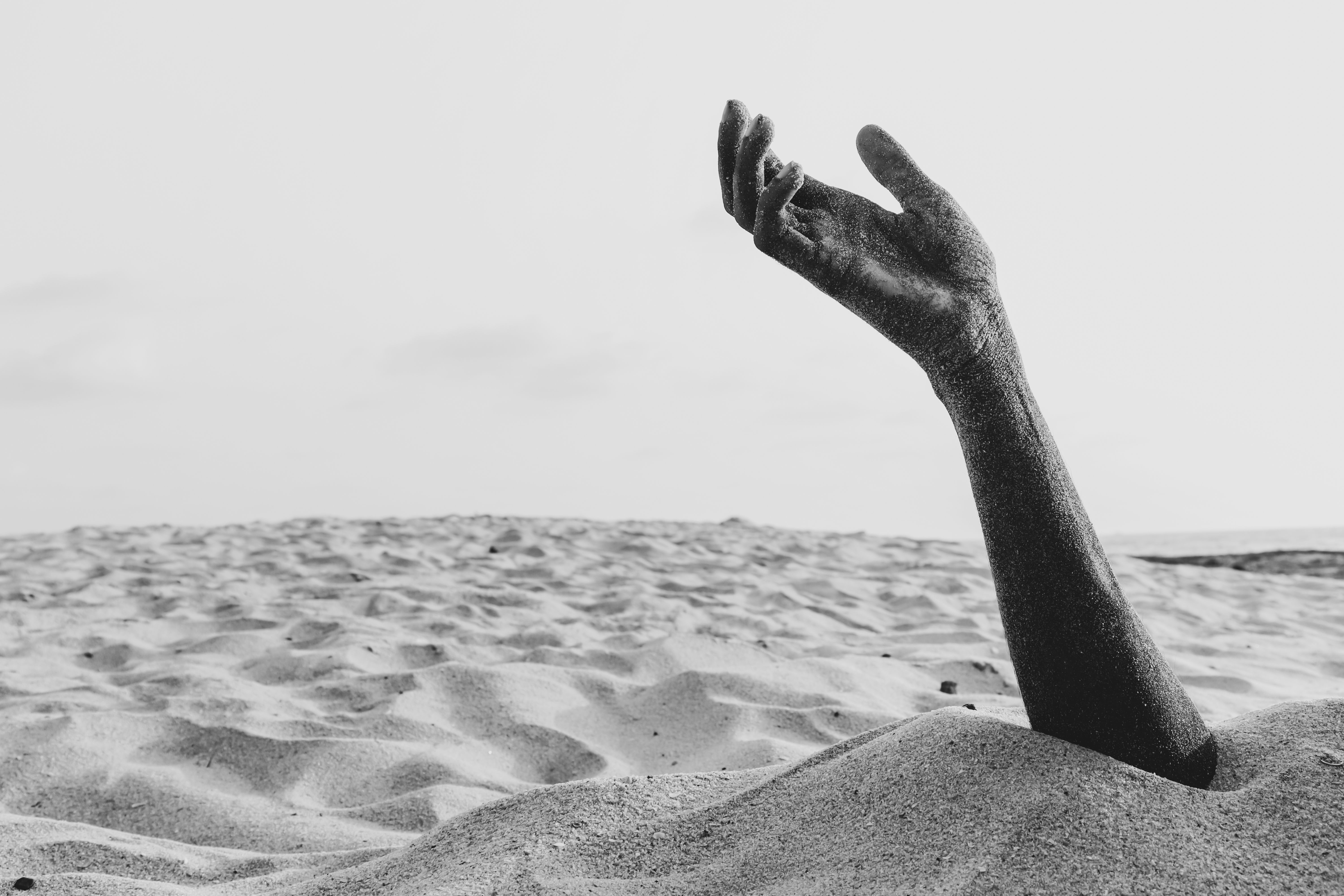 Hand of Man Buried in Sand on Beach · Free Stock Photo
