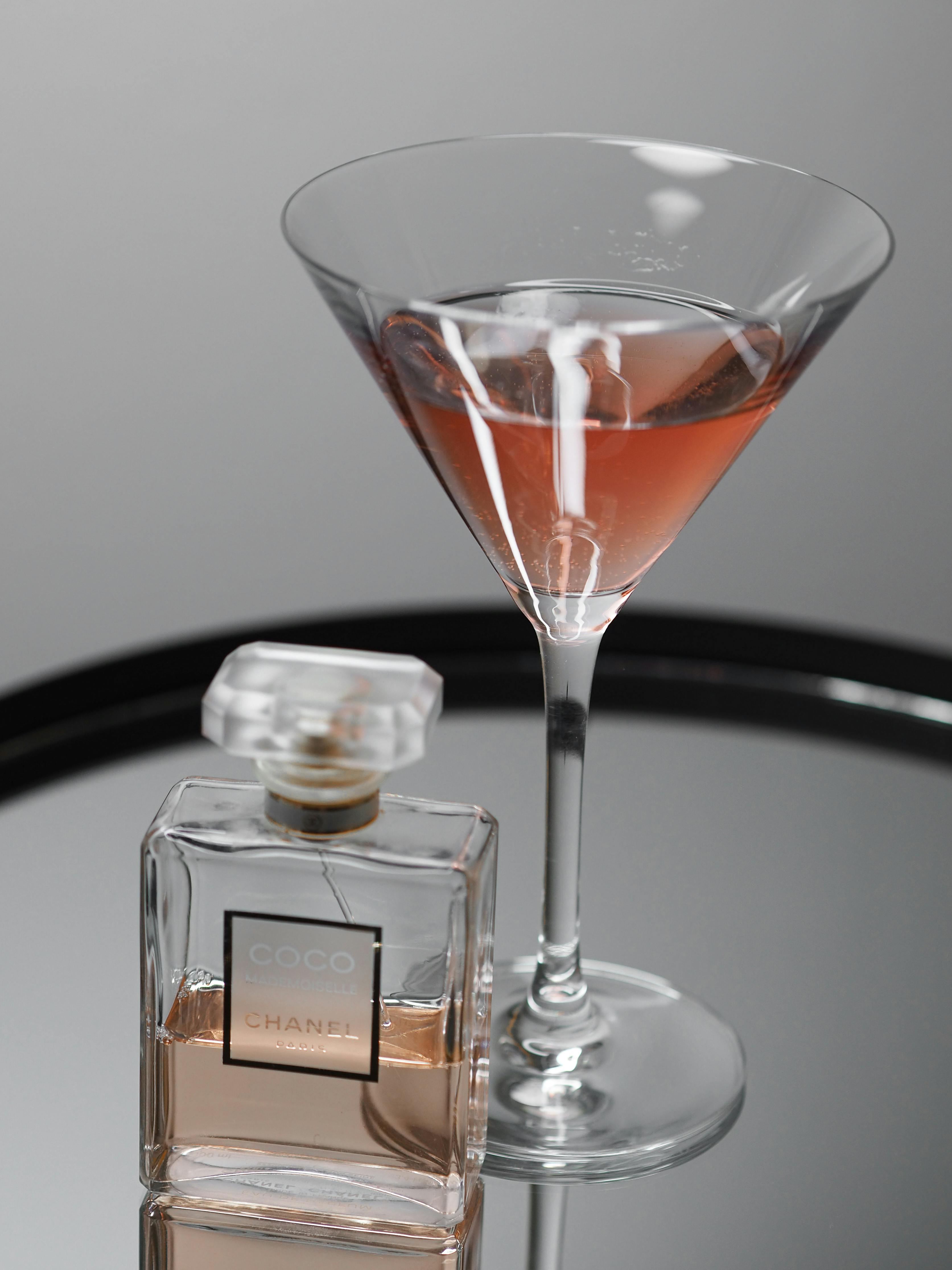 Perfume Bottle and Half a Lemon on a White Background · Free Stock Photo