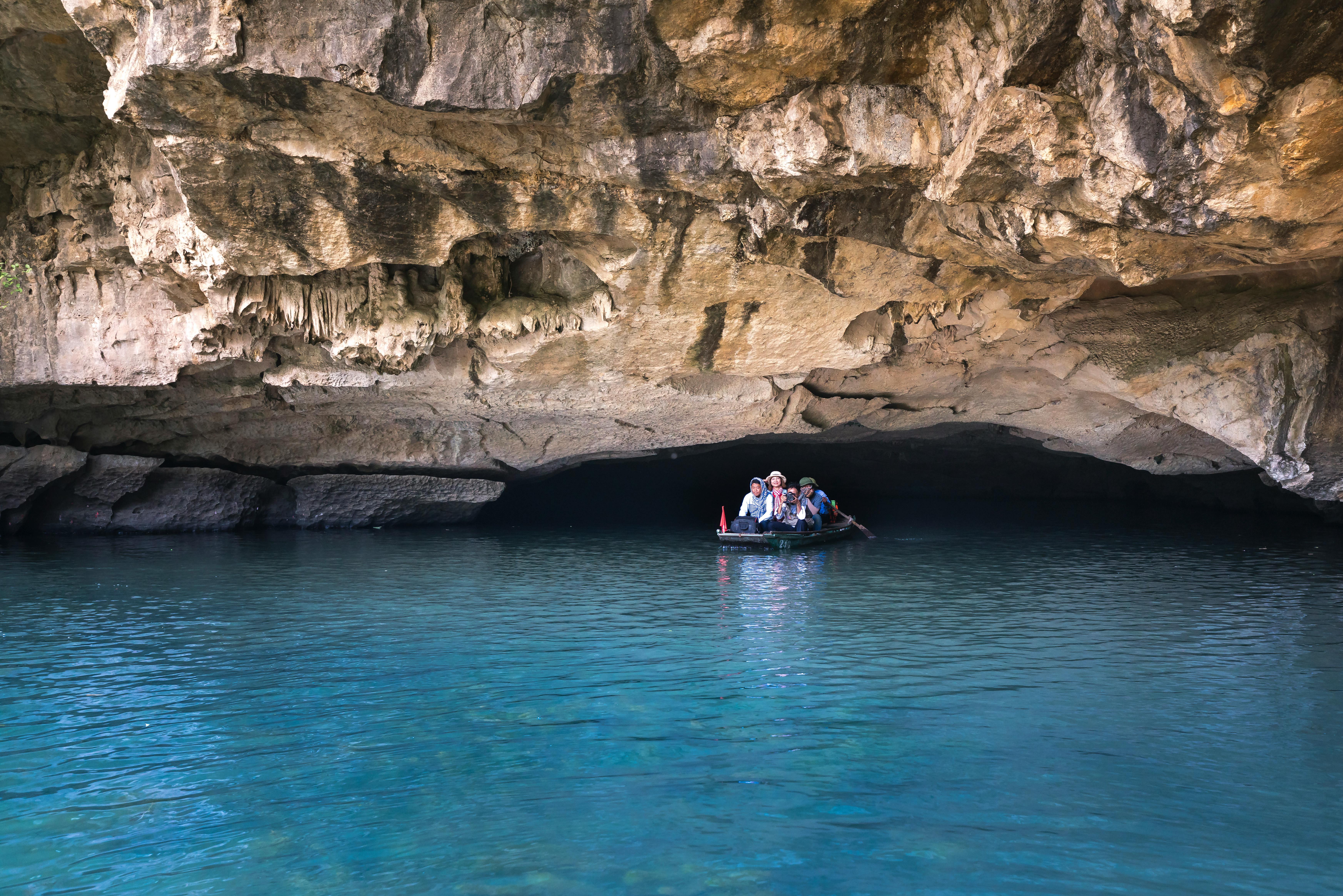 People on Boat Under Cave · Free Stock Photo