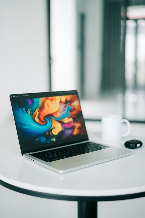 Laptop on a White Table · Free Stock Photo