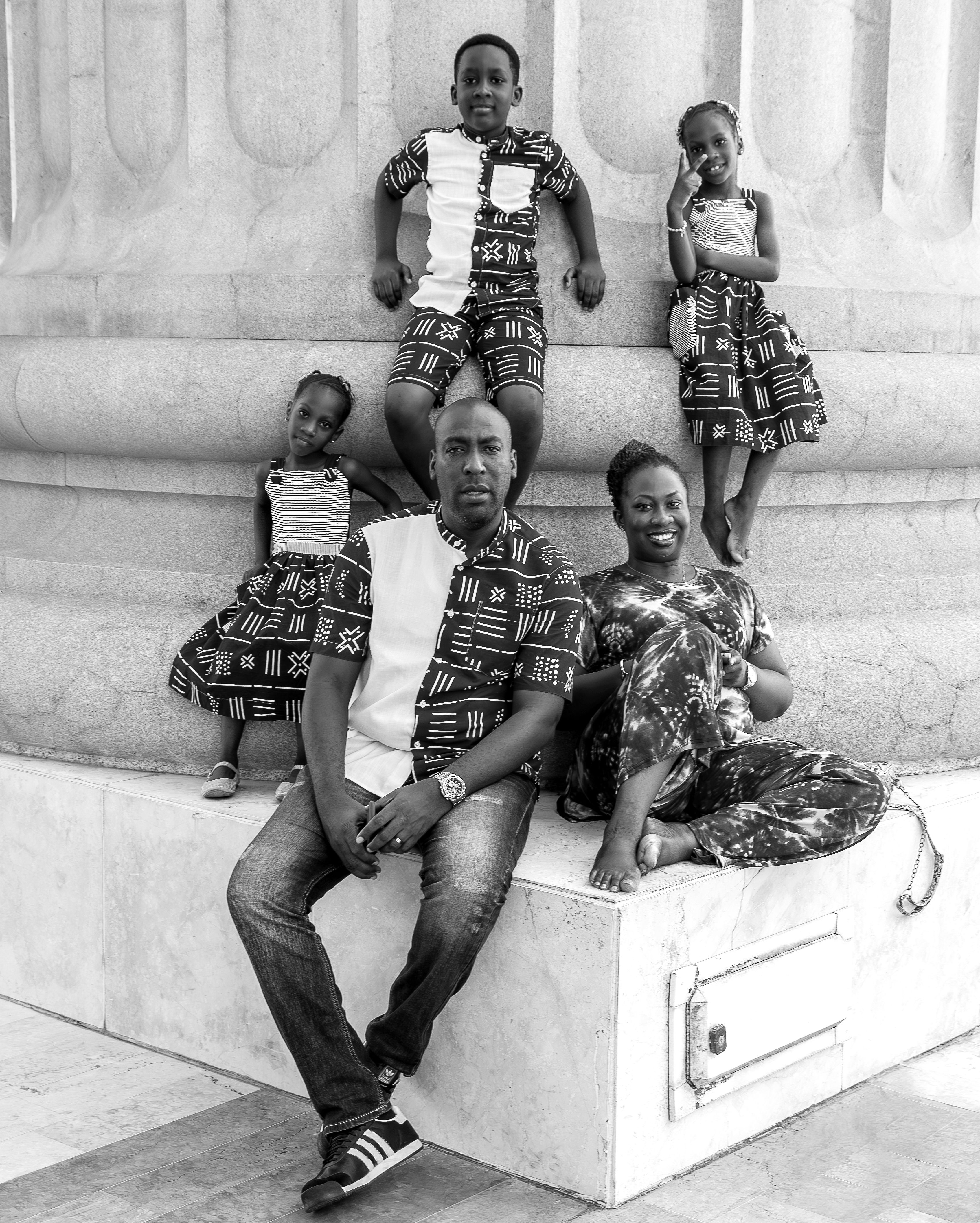 Family Sitting on the Base of a Huge Column · Free Stock Photo